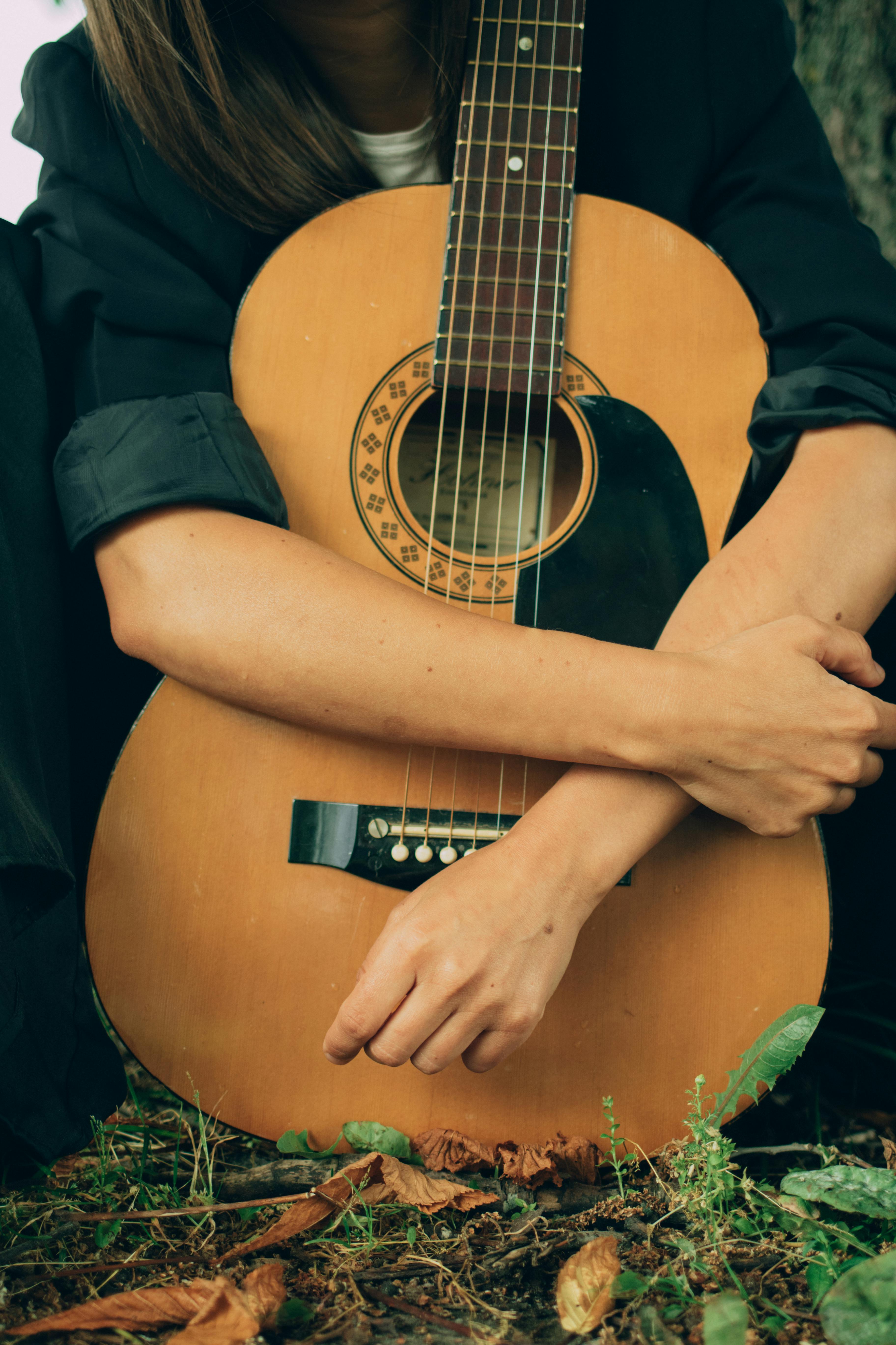 Person Embracing Acoustic Guitar · Free Stock Photo