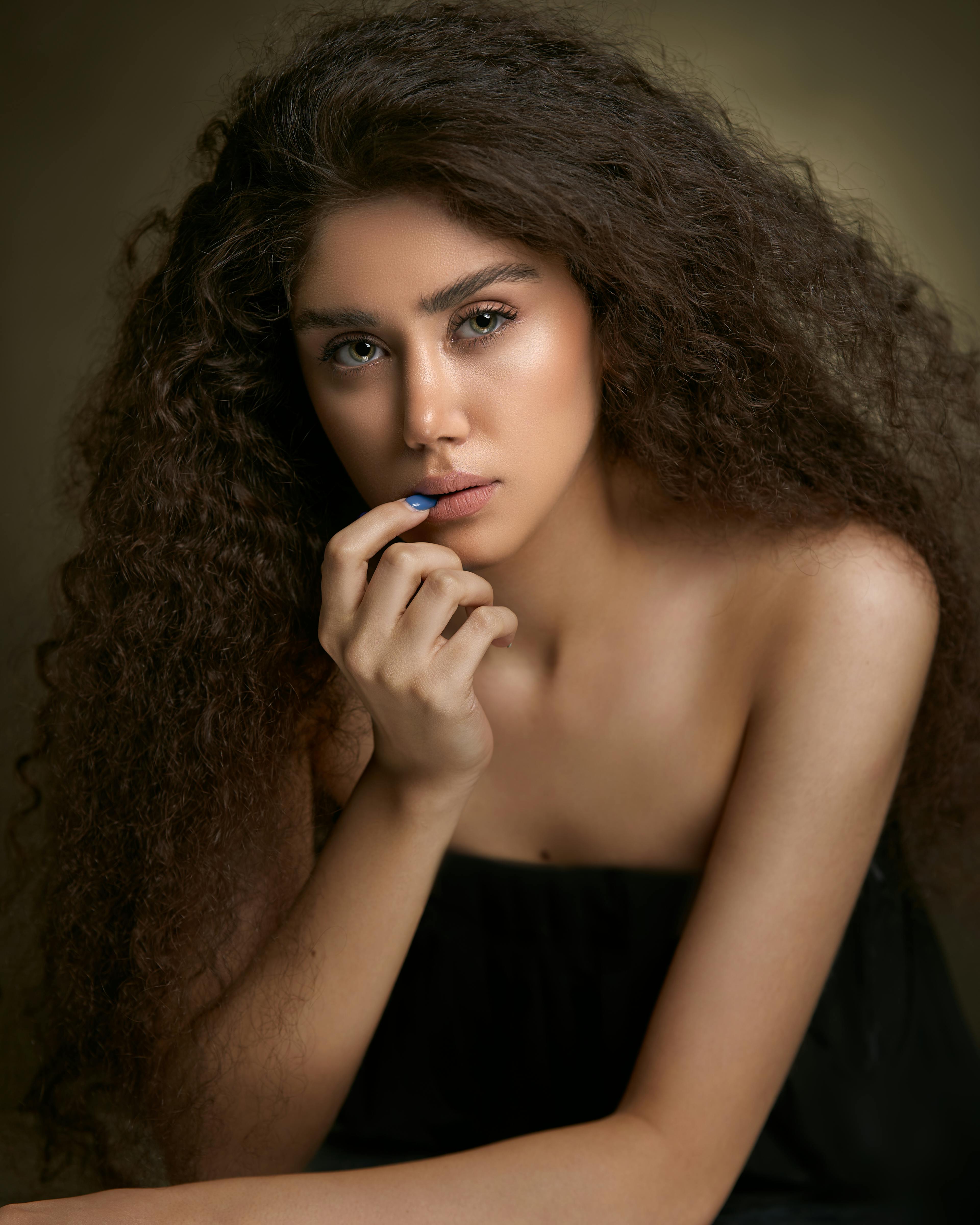Portrait of a Woman with Curly Hair · Free Stock Photo