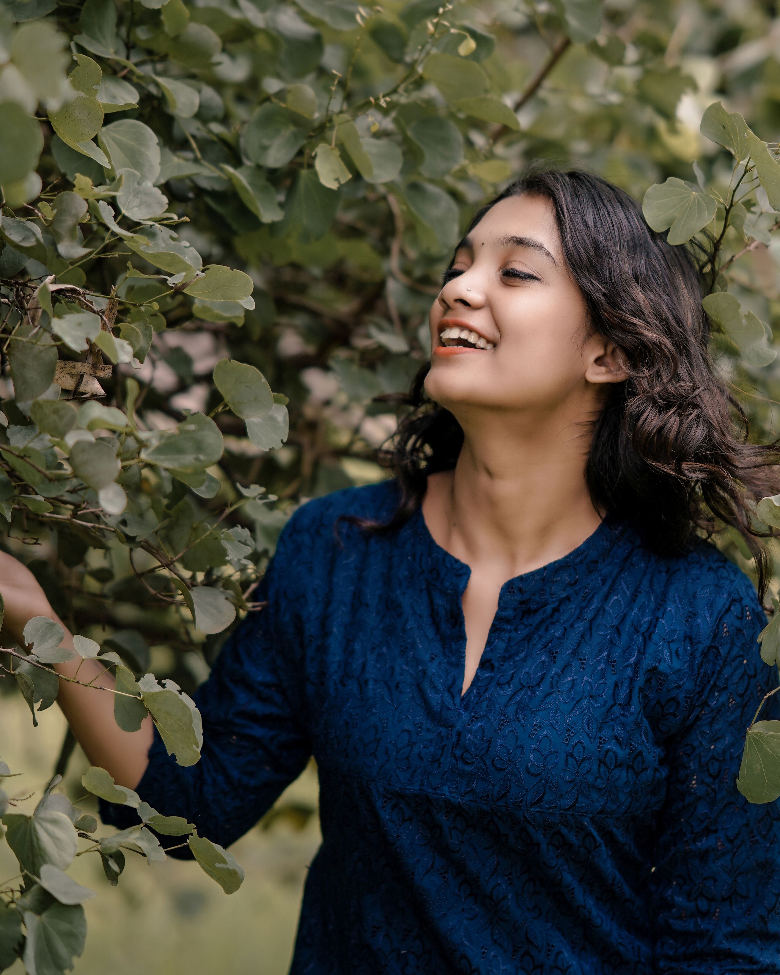 Beautiful Woman in Blue Top near Leaves · Free Stock Photo