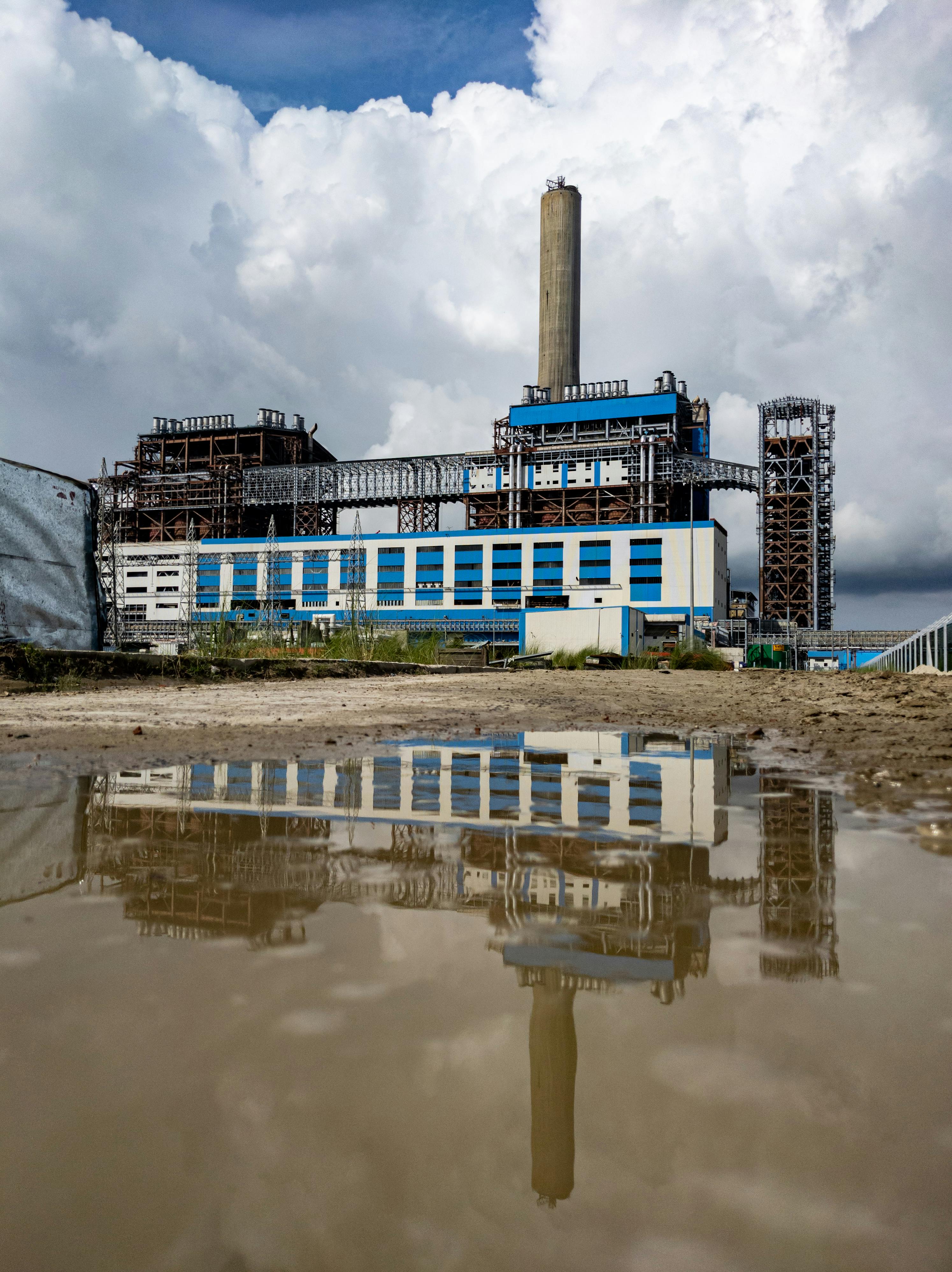 Factory Reflection in Puddle · Free Stock Photo