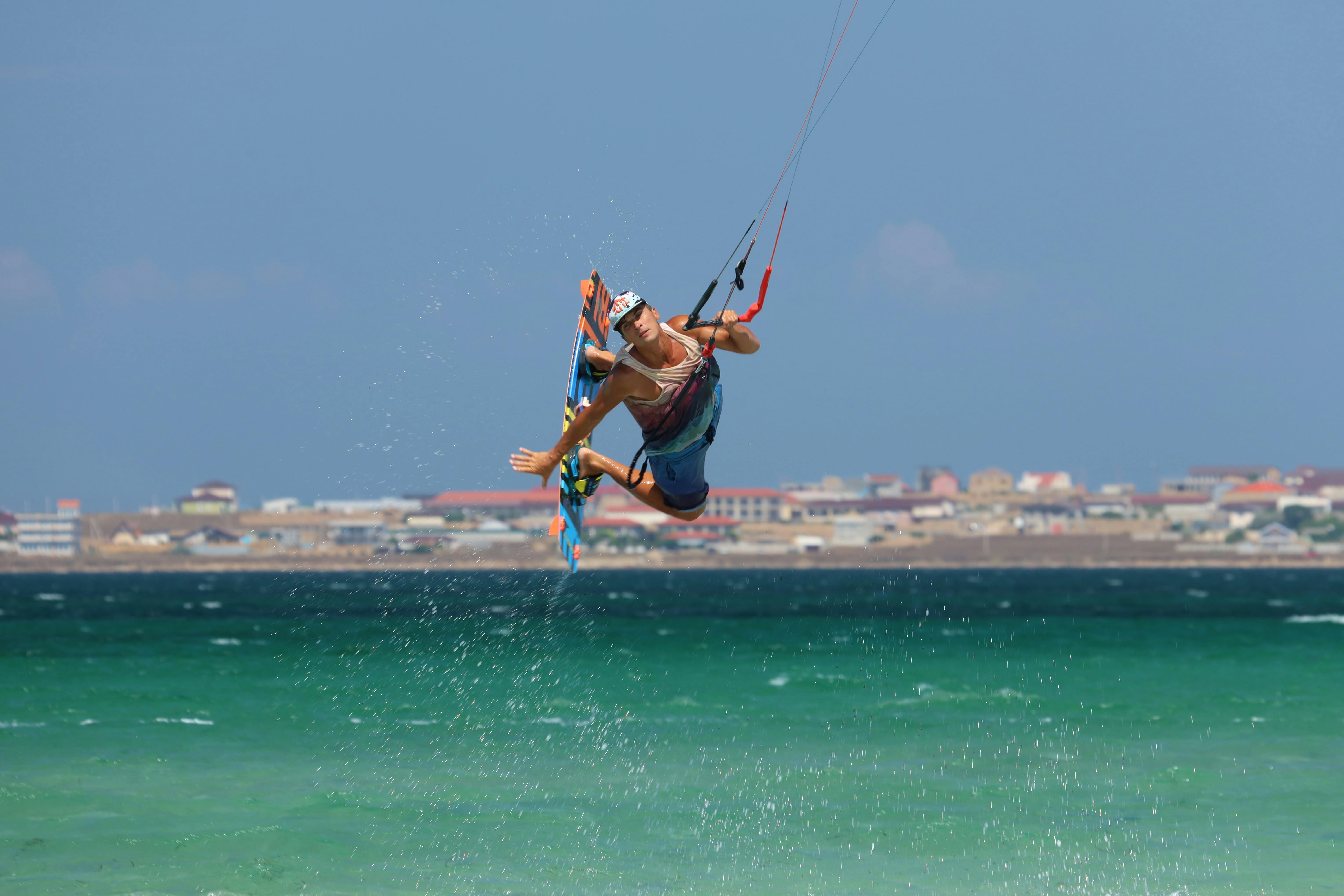 Man Striking Pose while Jumping into Water · Free Stock Photo