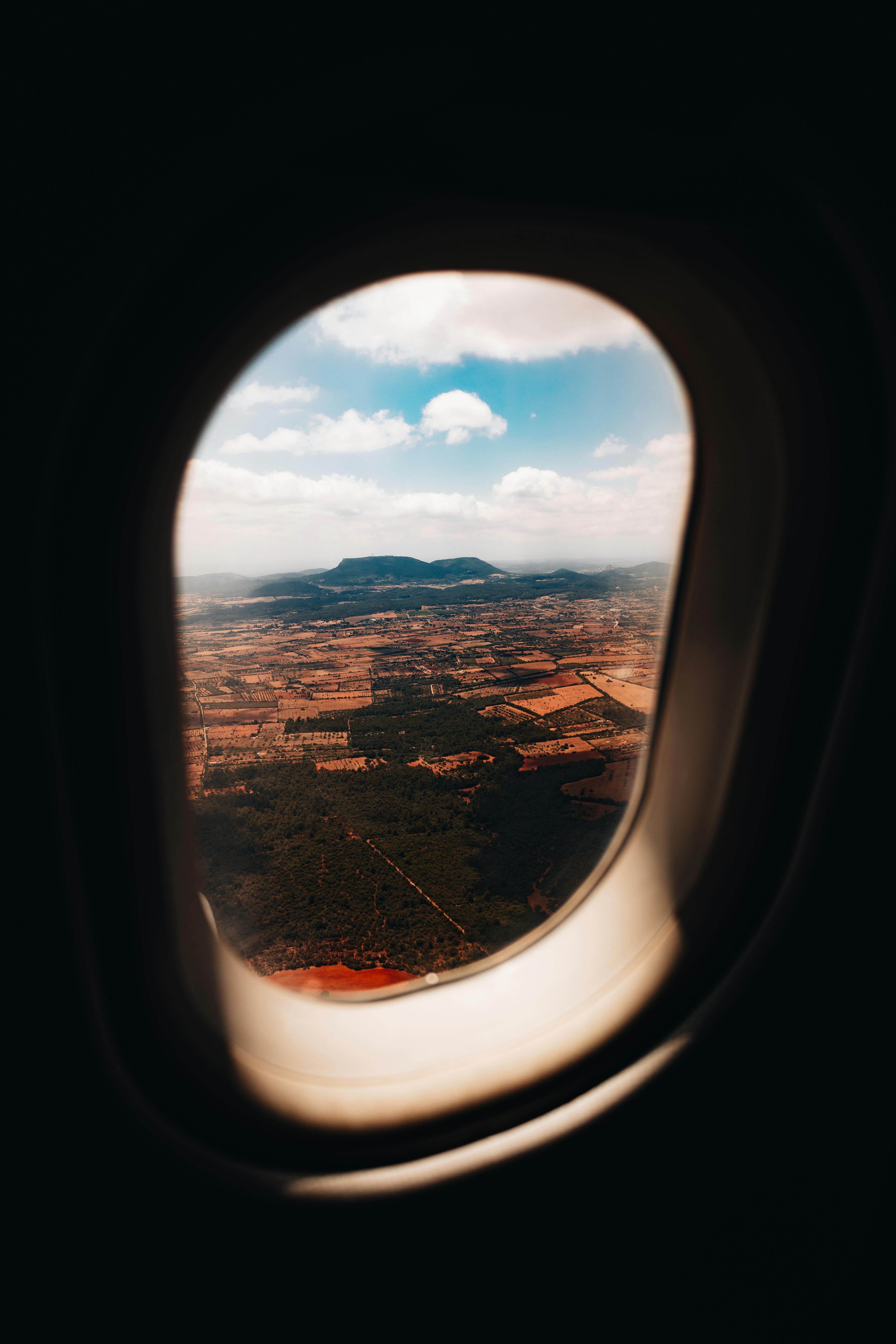 Landscape Photographed Through a Plane Window · Free Stock Photo