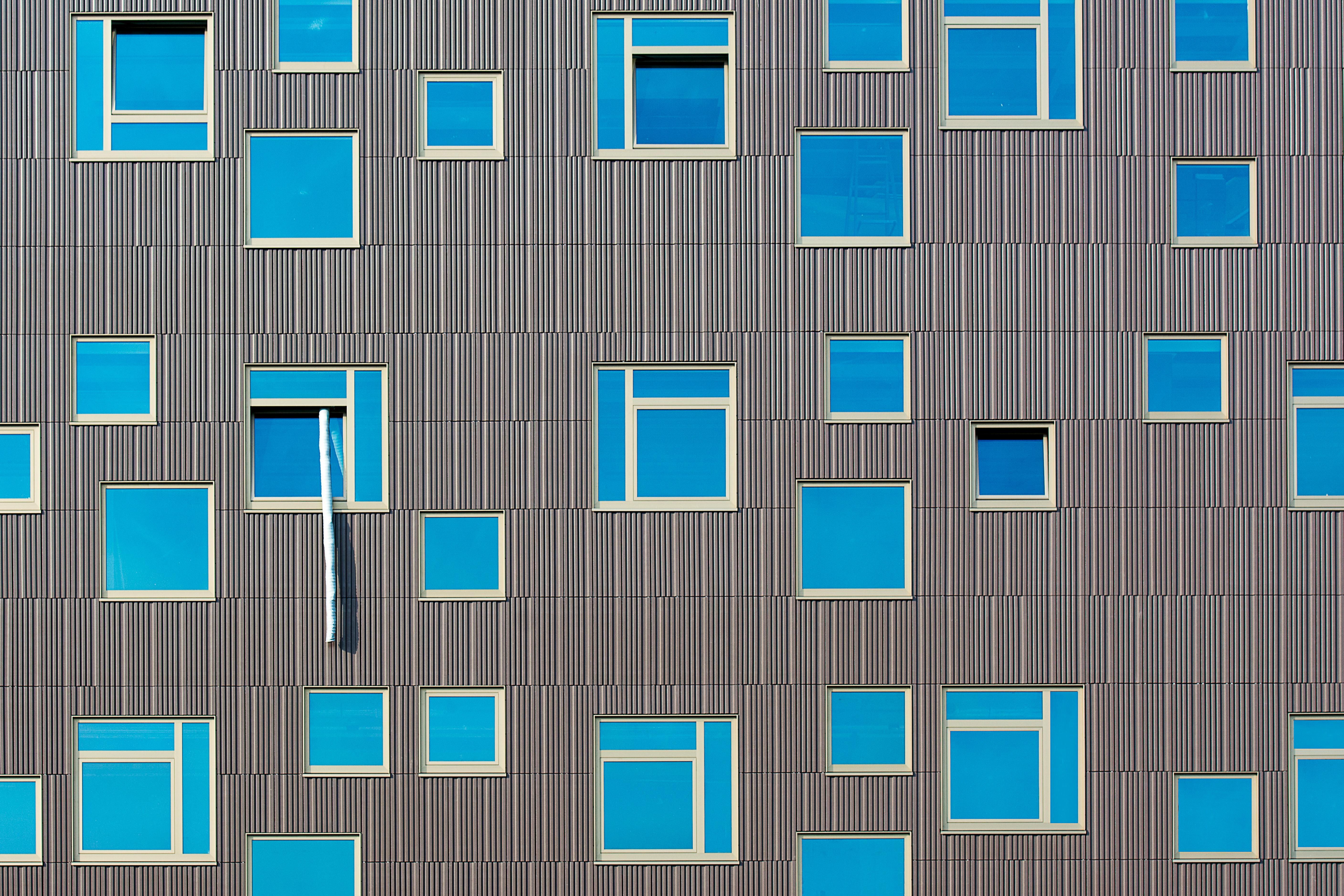 Windows Scattered Unevenly on Wall · Free Stock Photo