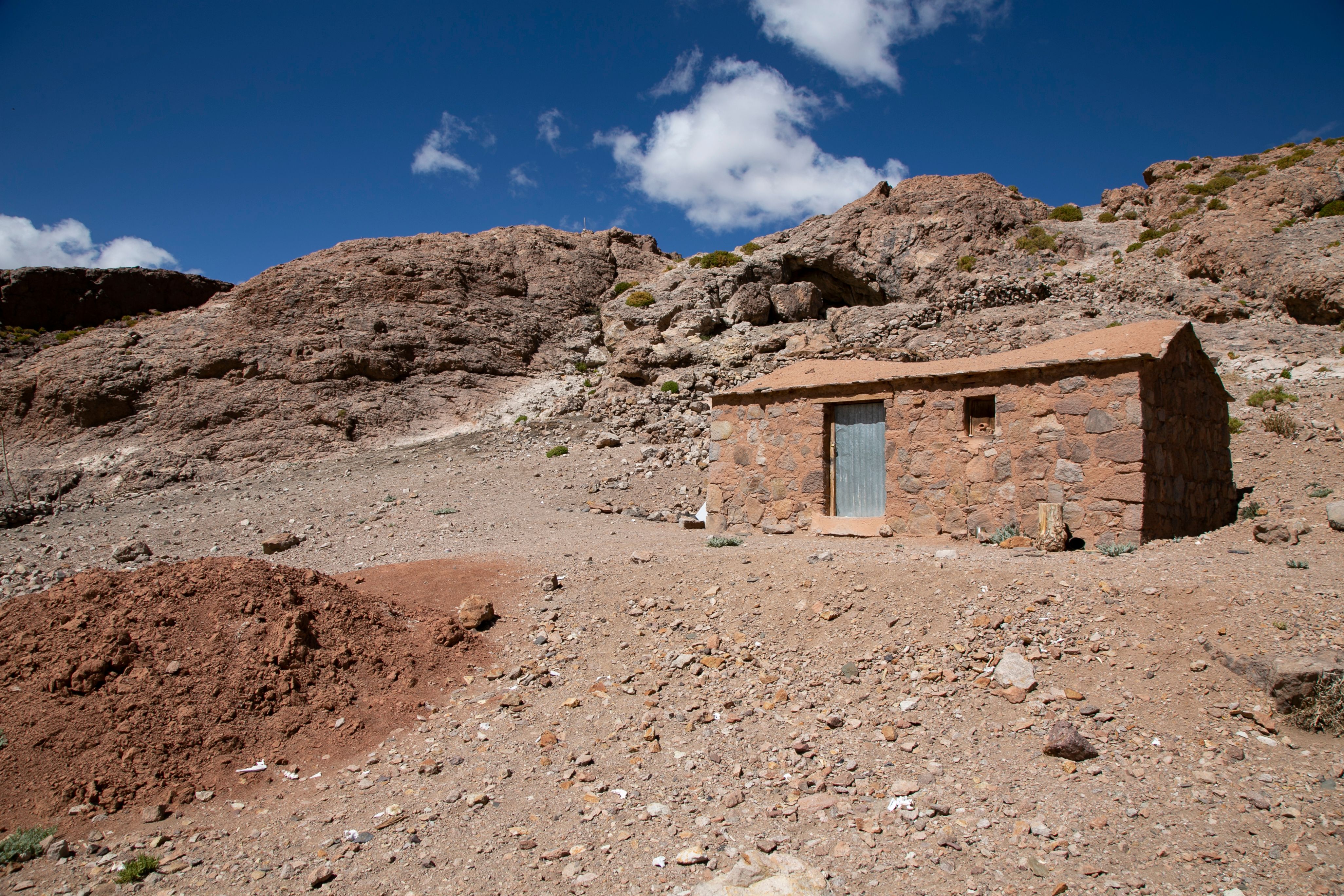 Abandoned Brick House on Rocky Wasteland · Free Stock Photo