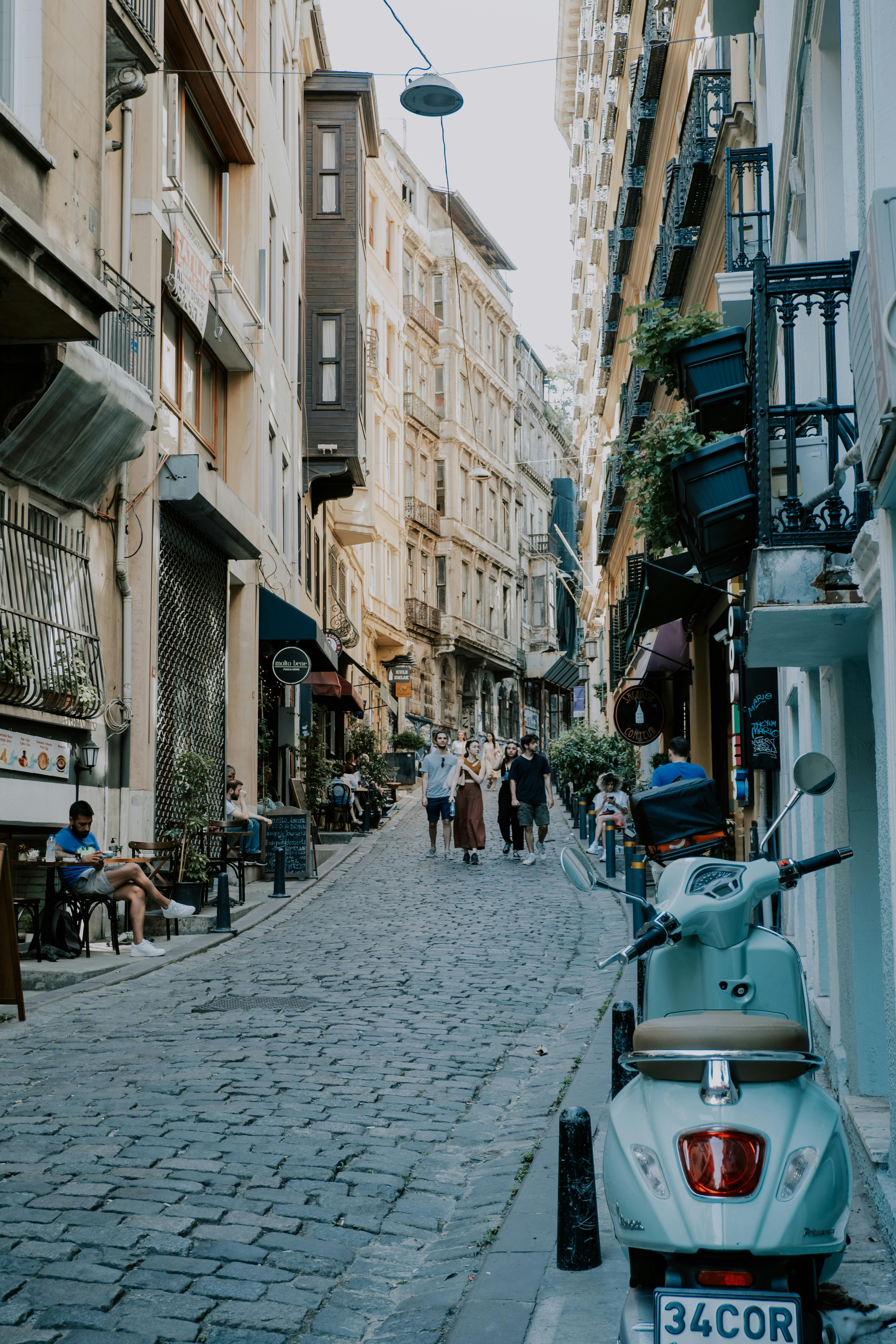 People Walking Between Buildings · Free Stock Photo