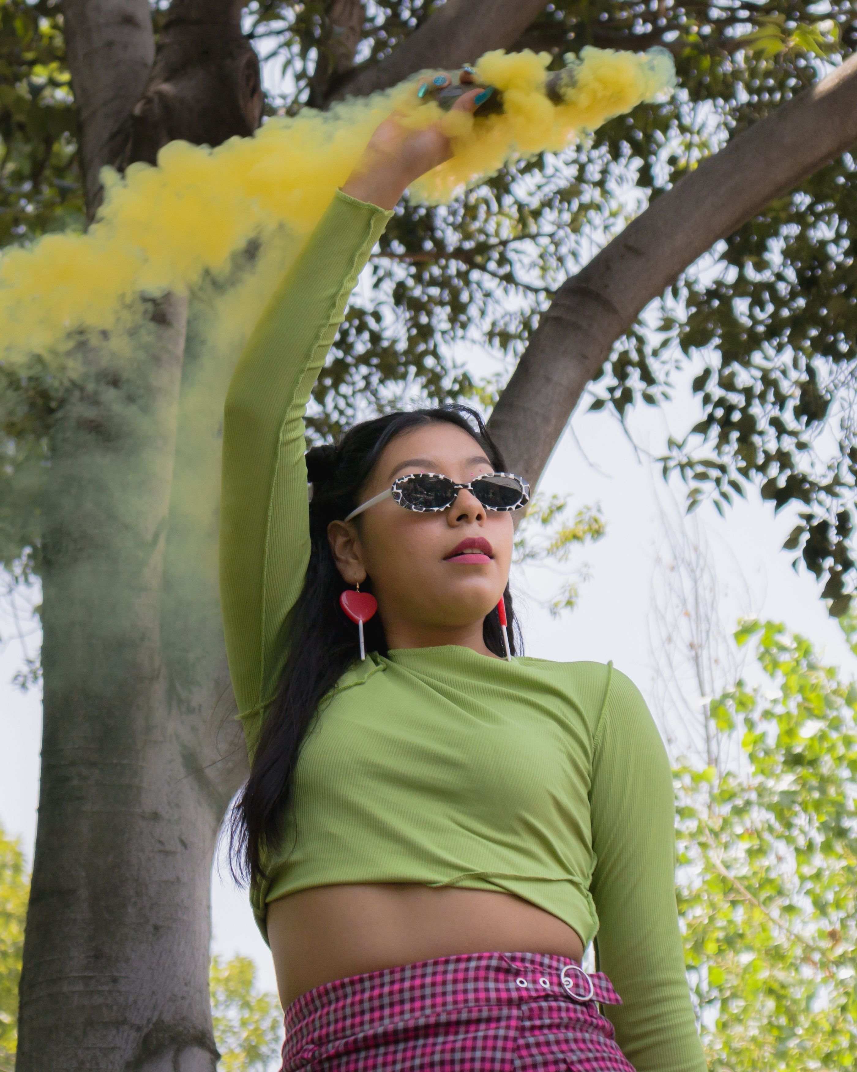 Young Trendy Woman Holding a Yellow Smoke Flare · Free Stock Photo
