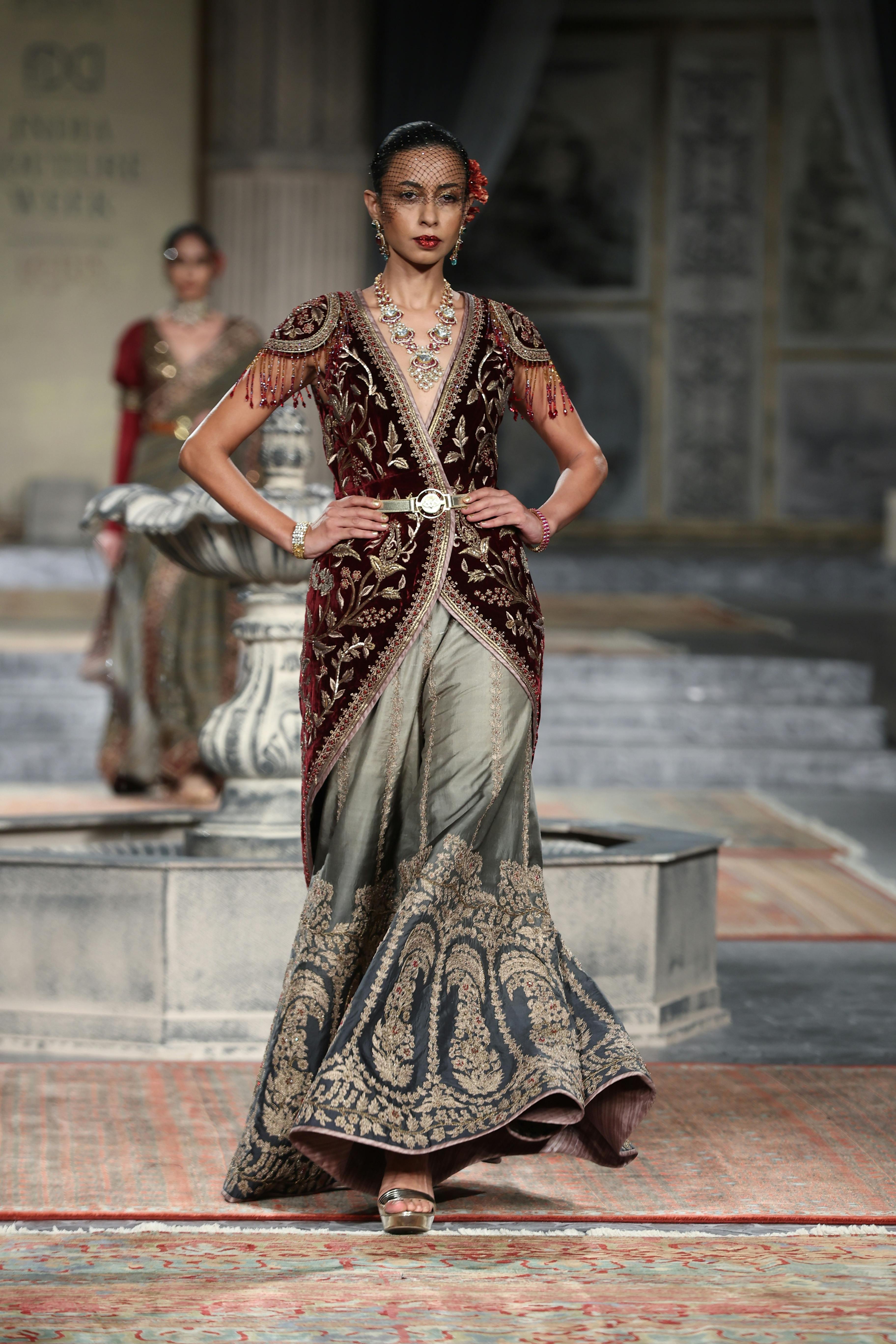 Model Walking on a Runway in Traditional Clothing · Free Stock Photo