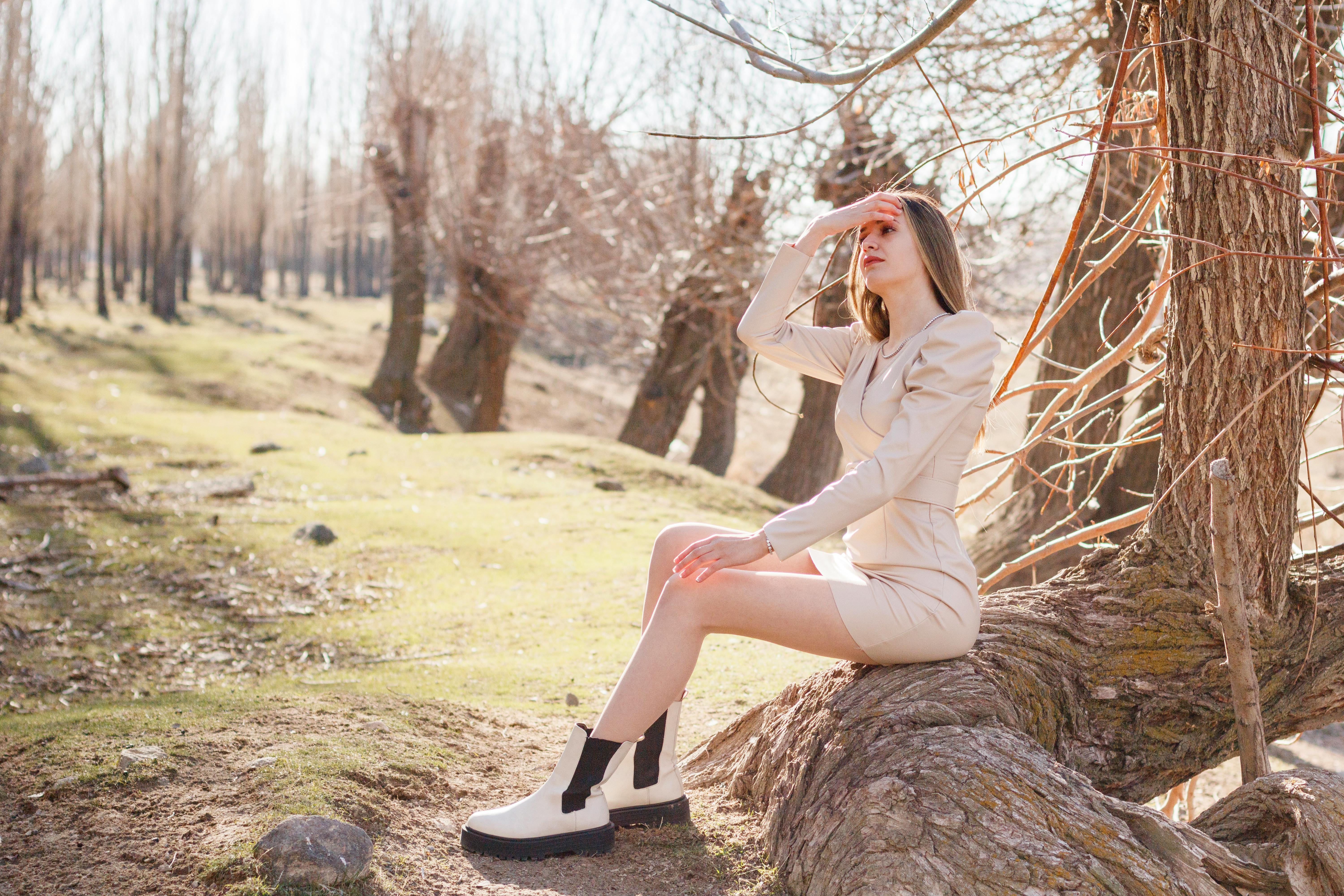 Woman Sitting on Tree Trunk · Free Stock Photo