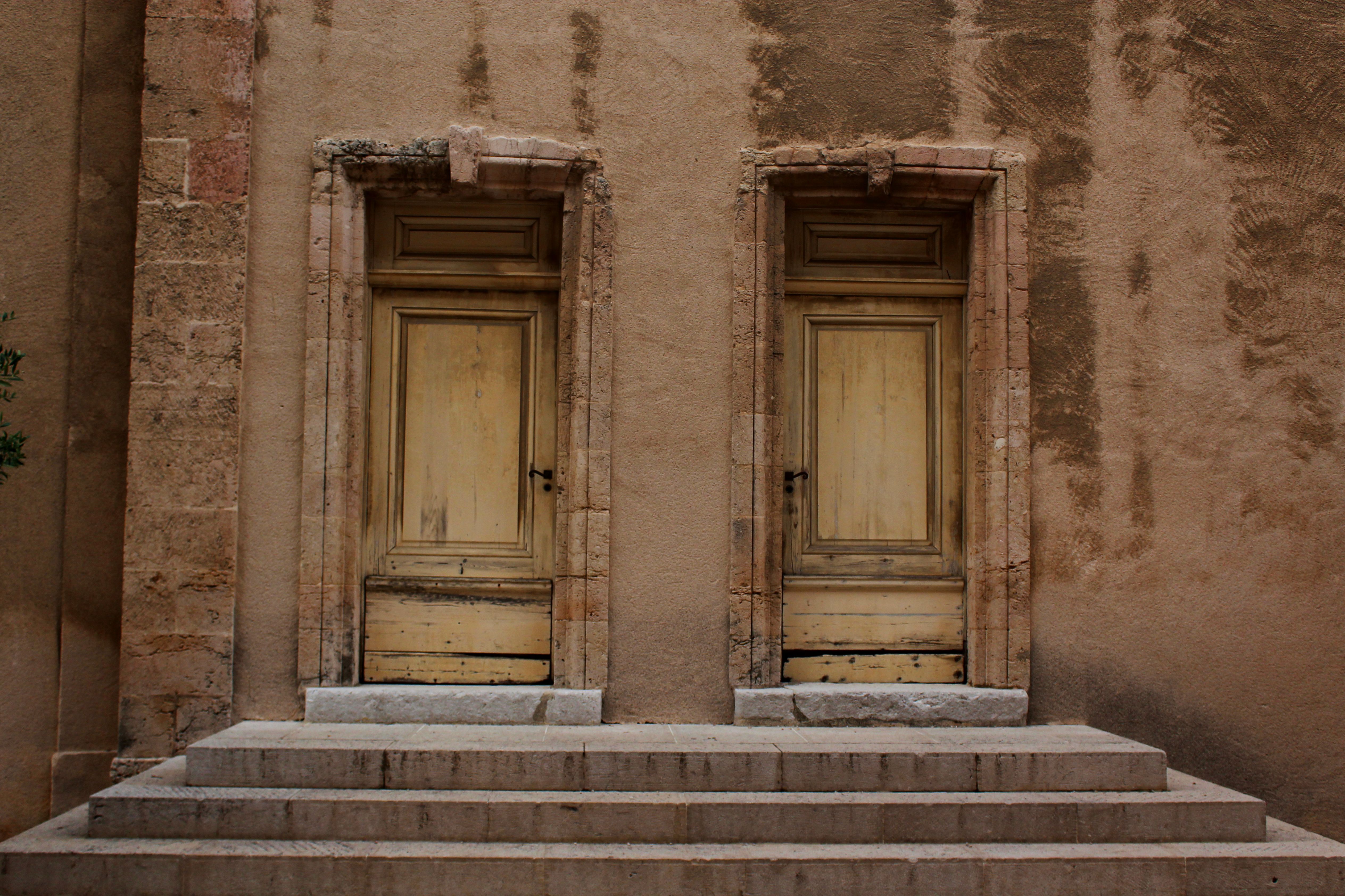 Wooden Doors in Ancient Stone Building · Free Stock Photo