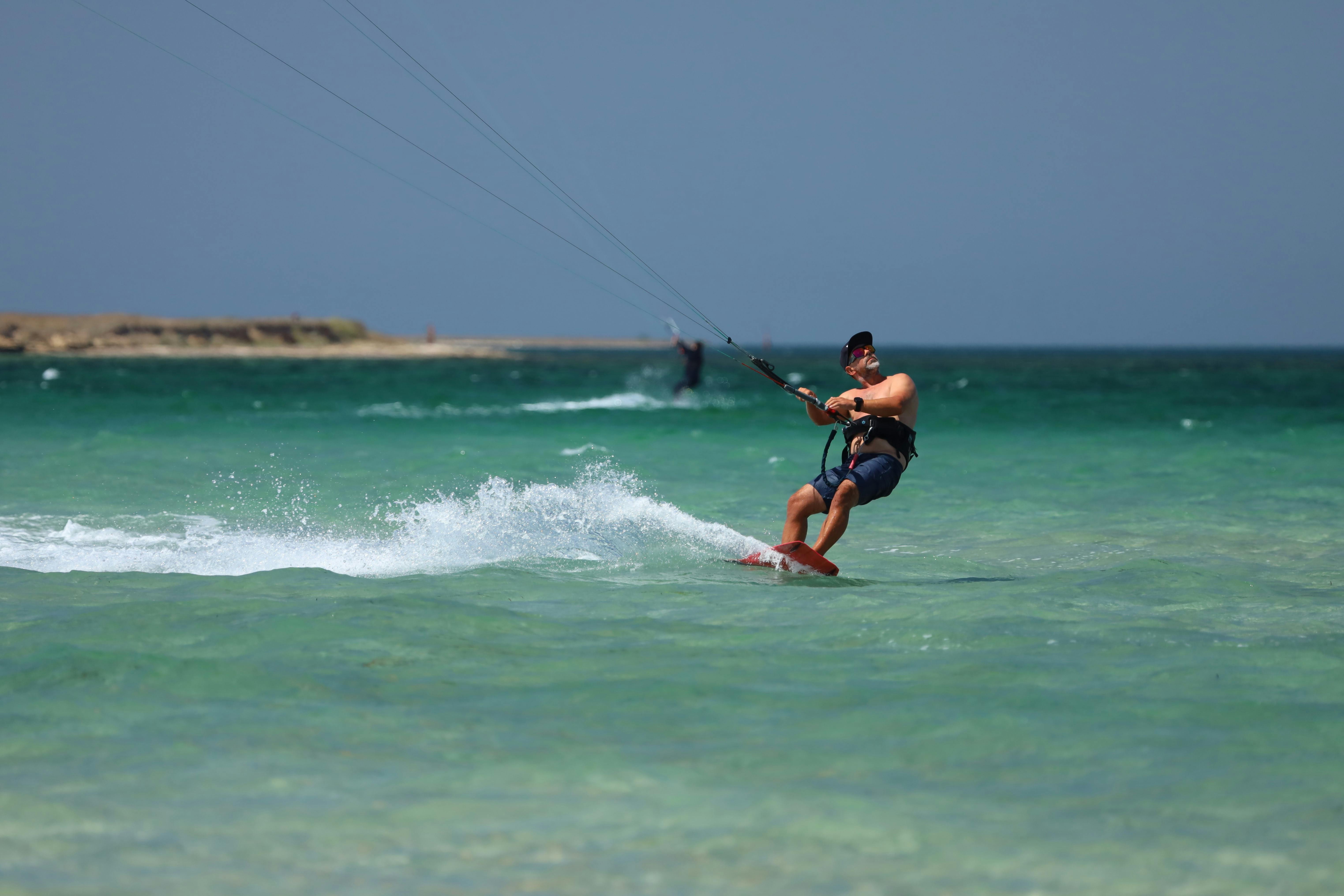 A Person Kitesurfing on the Beach · Free Stock Photo