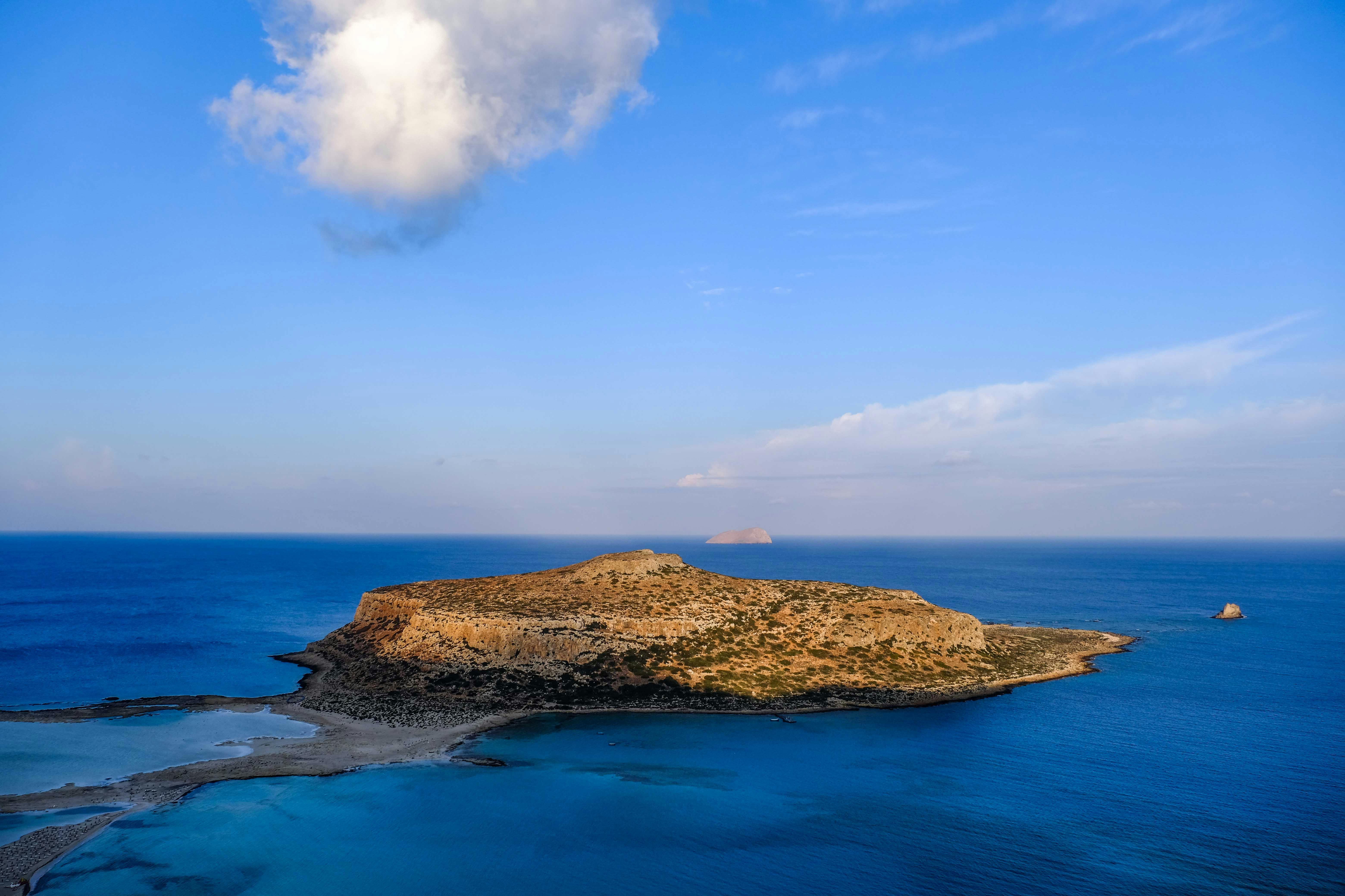 Brown and Green Island Under Blue Sky · Free Stock Photo