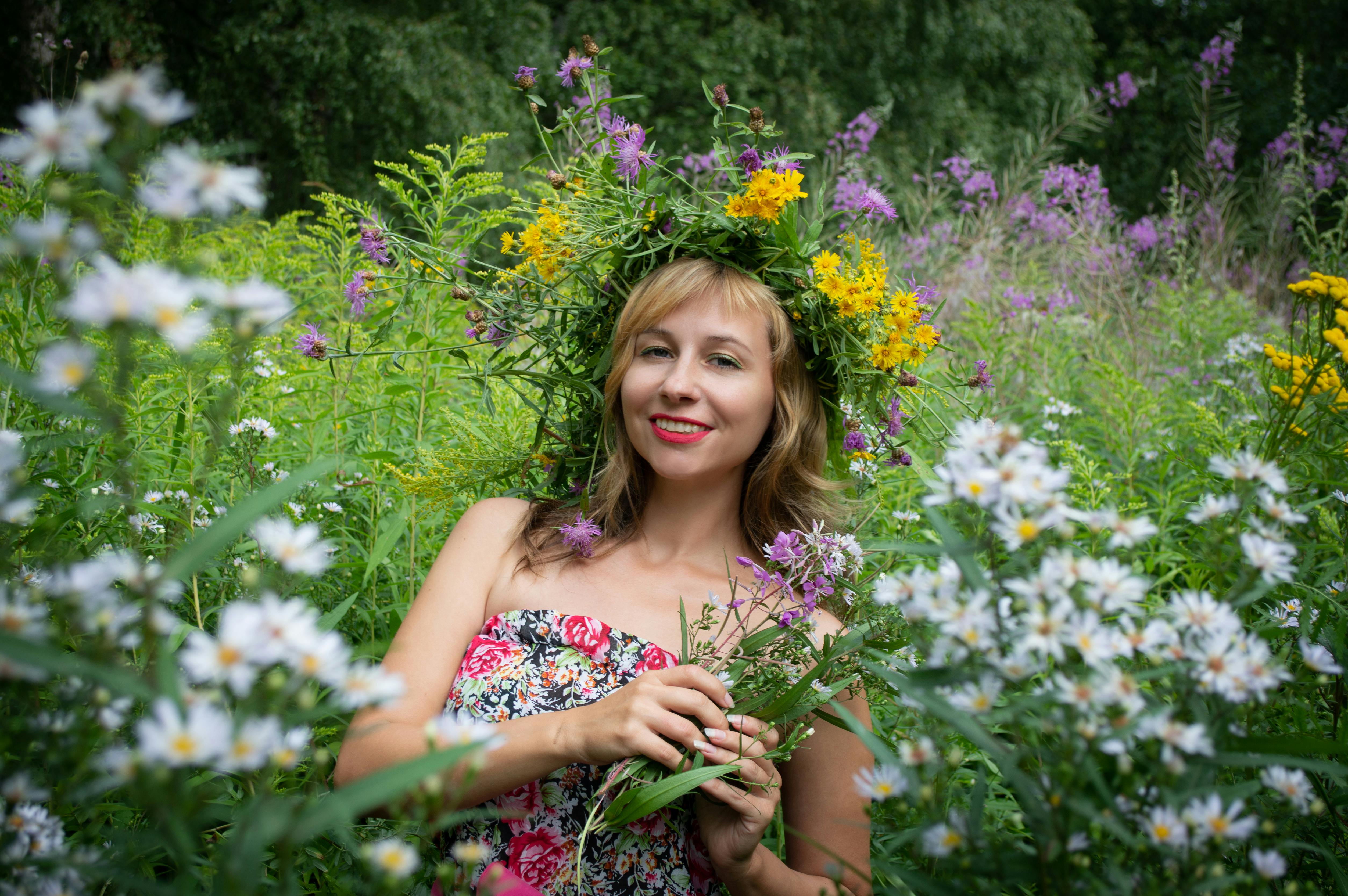 Woman Squatting Beside Purple Flowers · Free Stock Photo