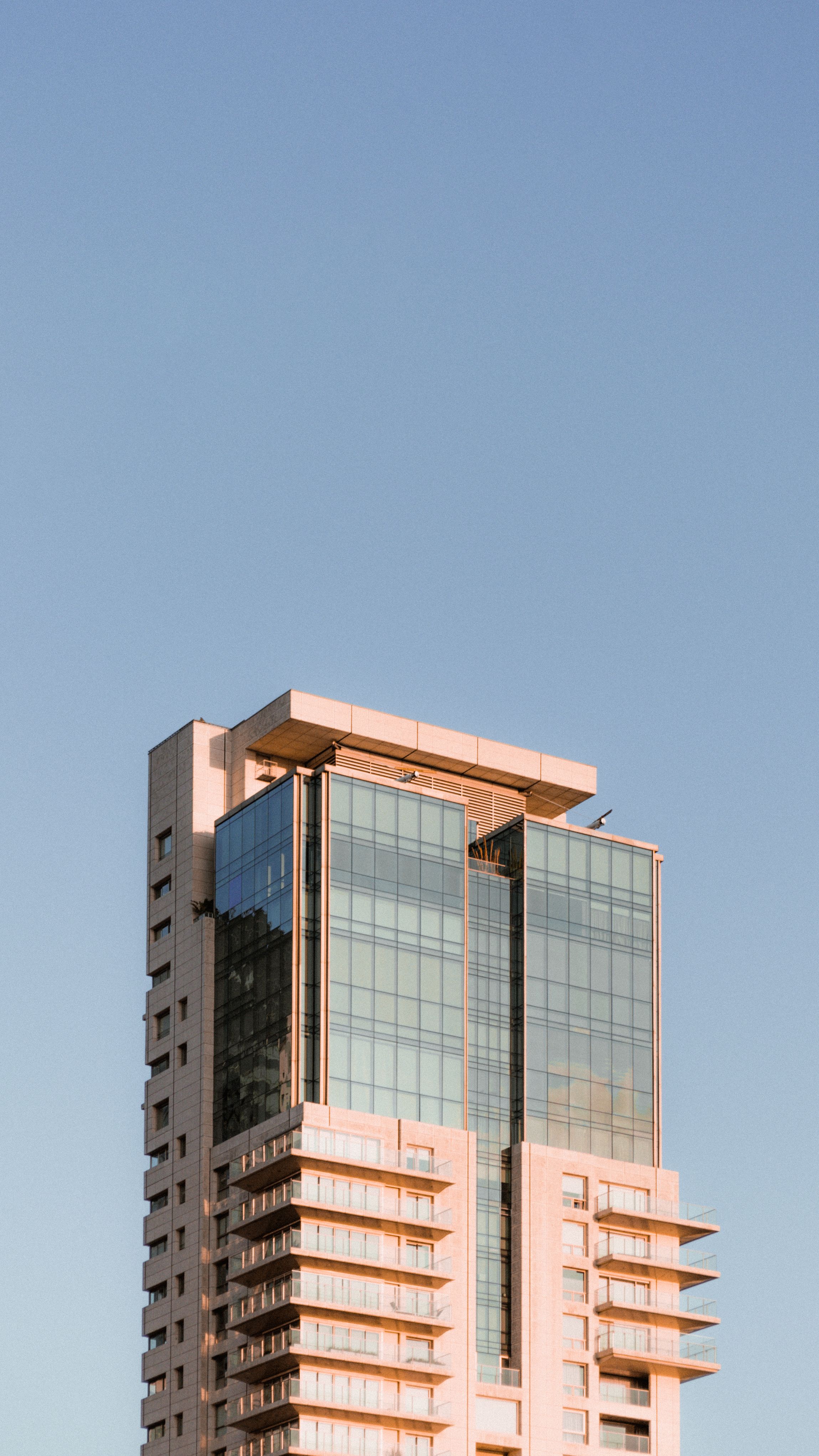 A High-Rise Building Under the Blue Sky · Free Stock Photo