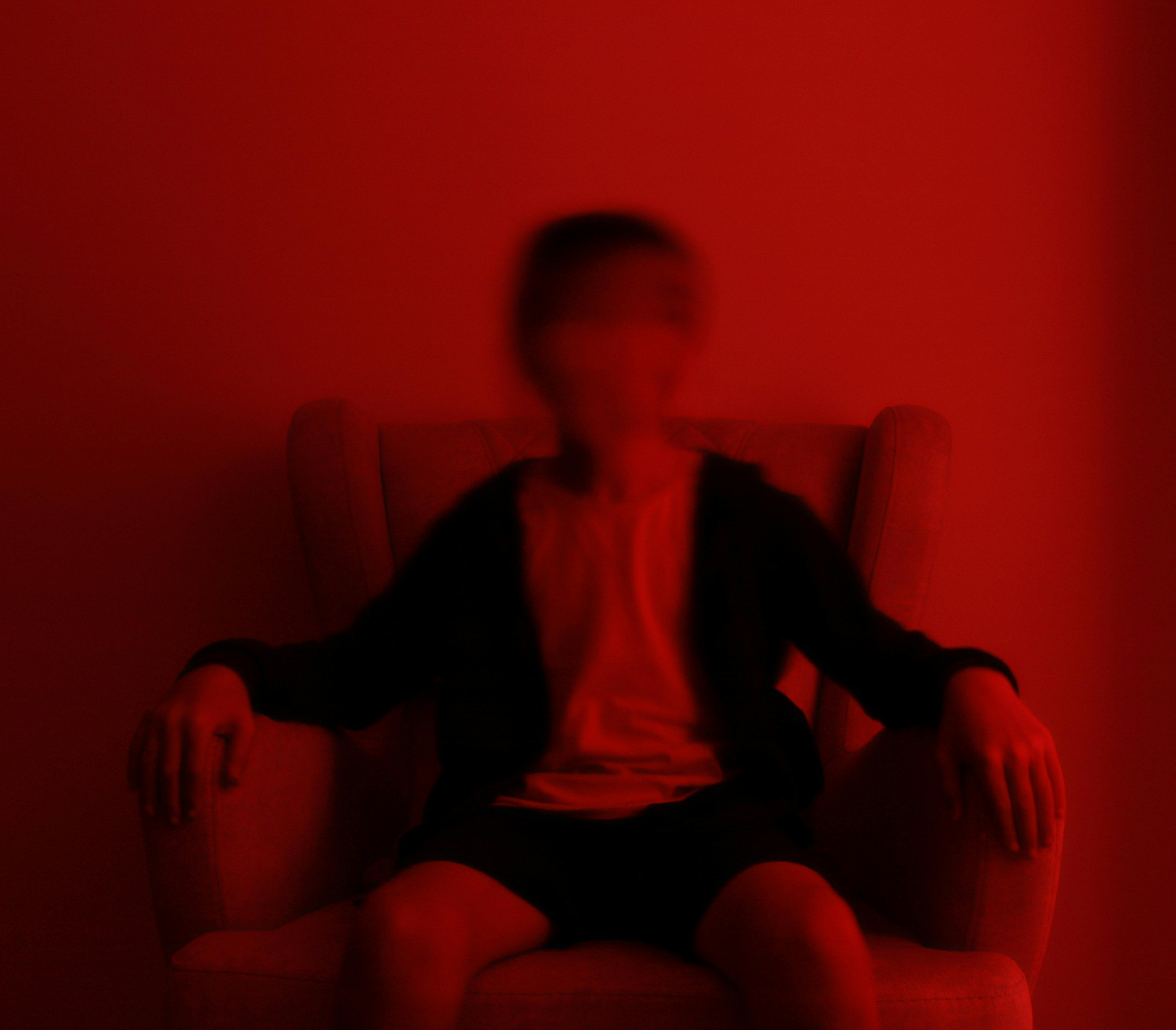 Blurred Model Sitting on Armchair · Free Stock Photo