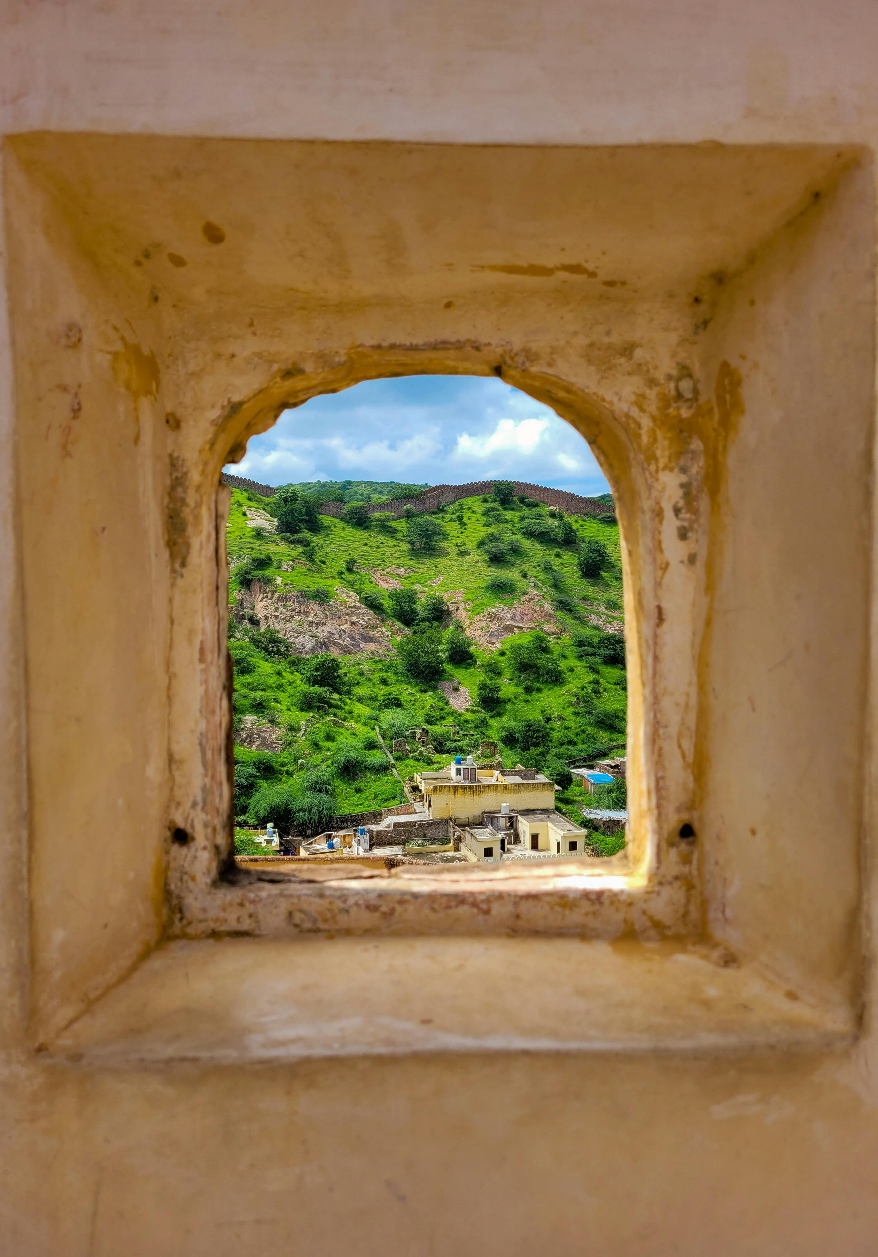 Outside View from an Arched Window · Free Stock Photo