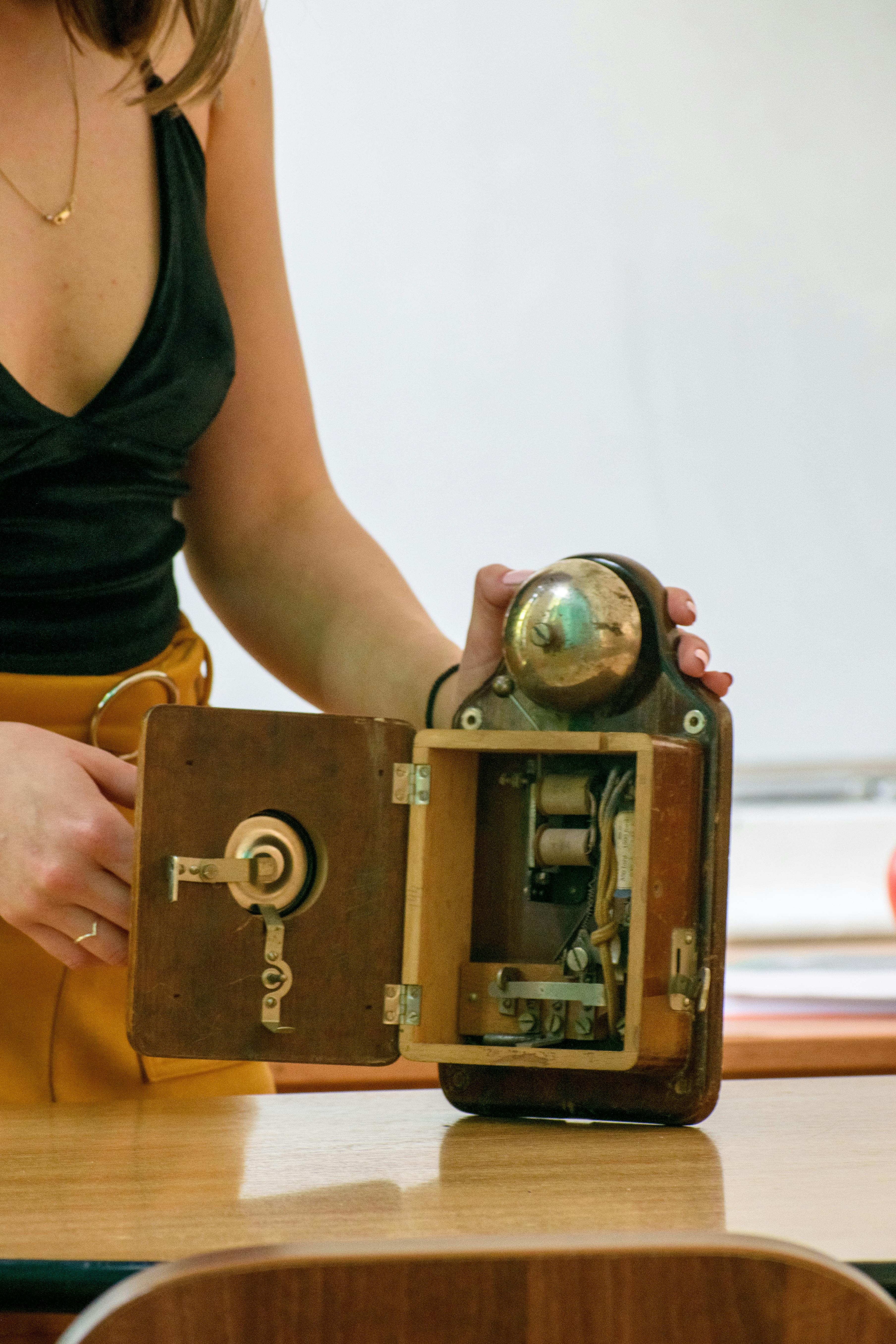 A Woman in Black Tank Top Holding Vintage Clock · Free Stock Photo