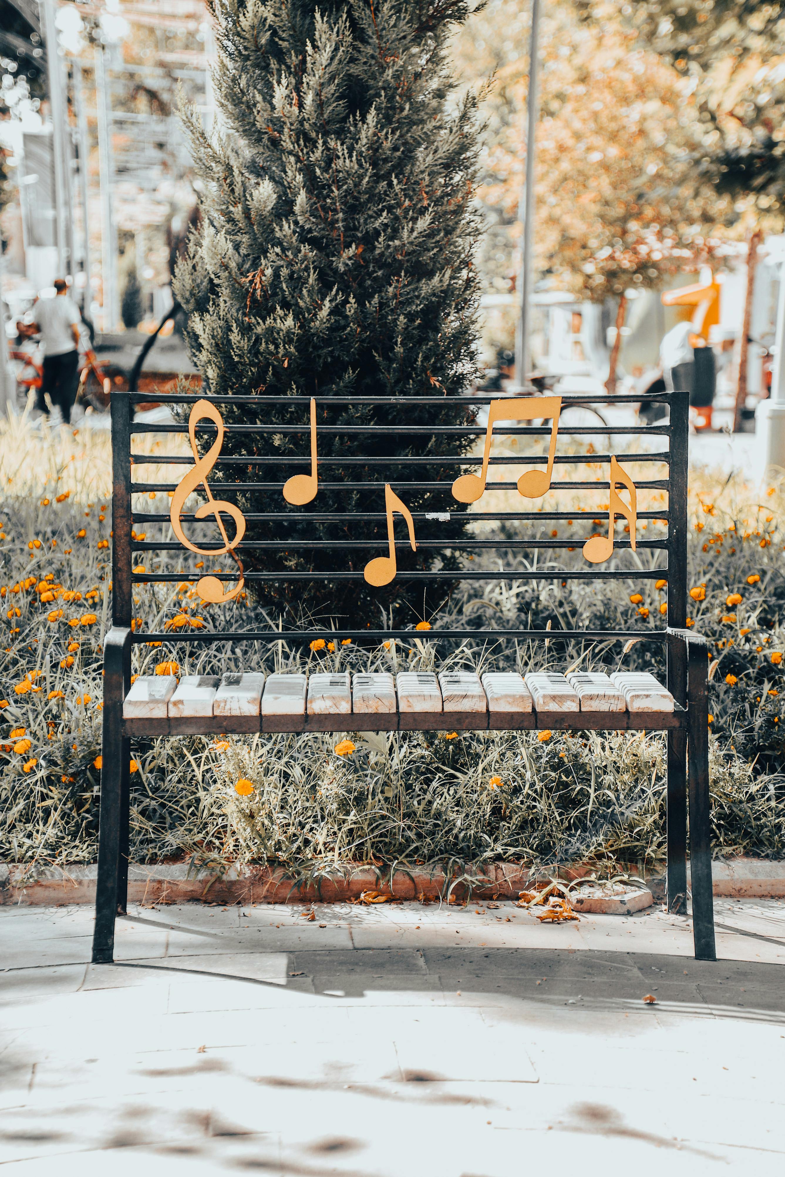 A Steel Framed Bench with Music Notes on Back Rest · Free Stock Photo