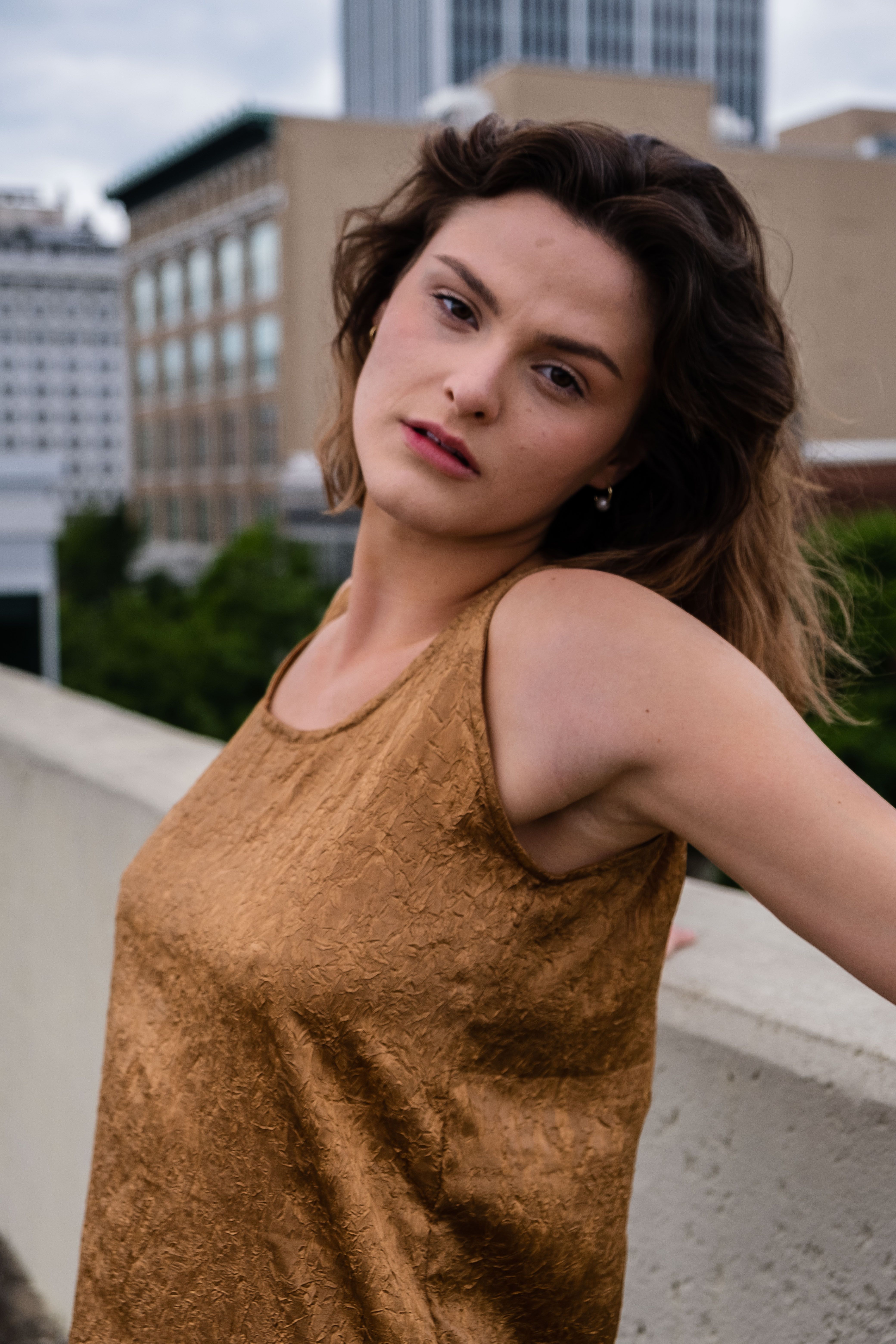 Beautiful Woman Standing in Front of Concrete Railing · Free Stock Photo
