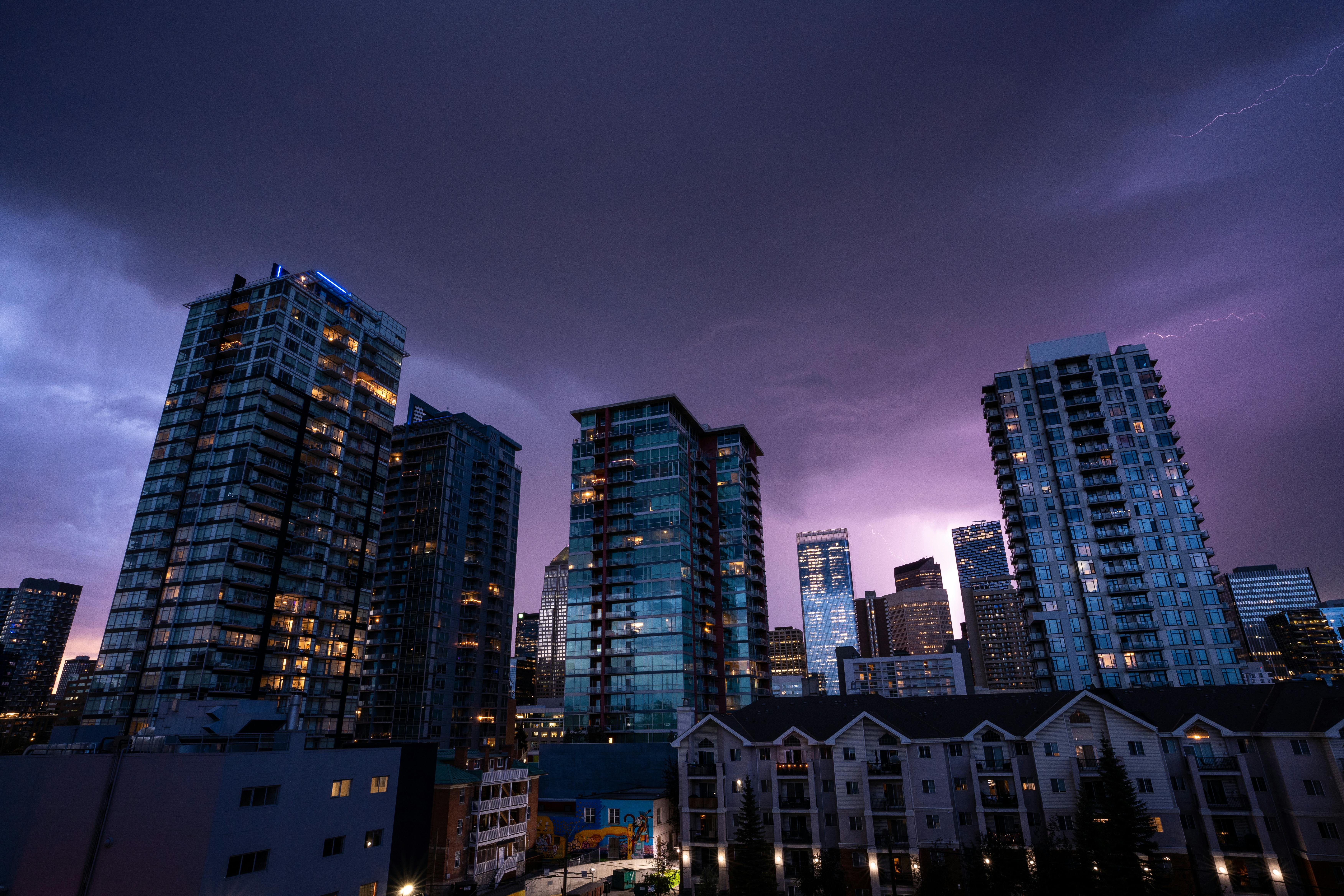 A Low Angle Shot of City Buildings at Night · Free Stock Photo
