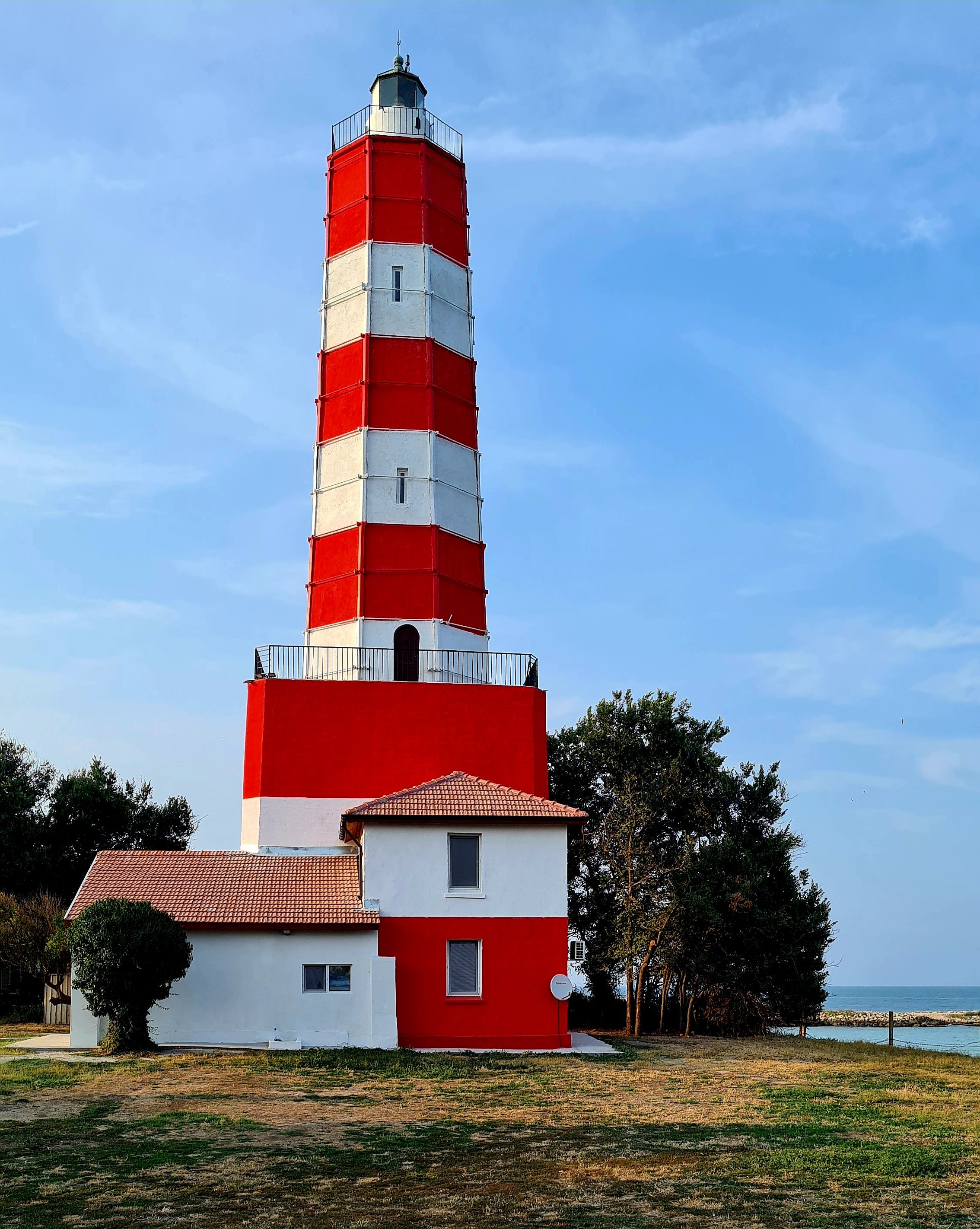 Red and White Lighthouse Tower Under the Blue Sky · Free Stock Photo