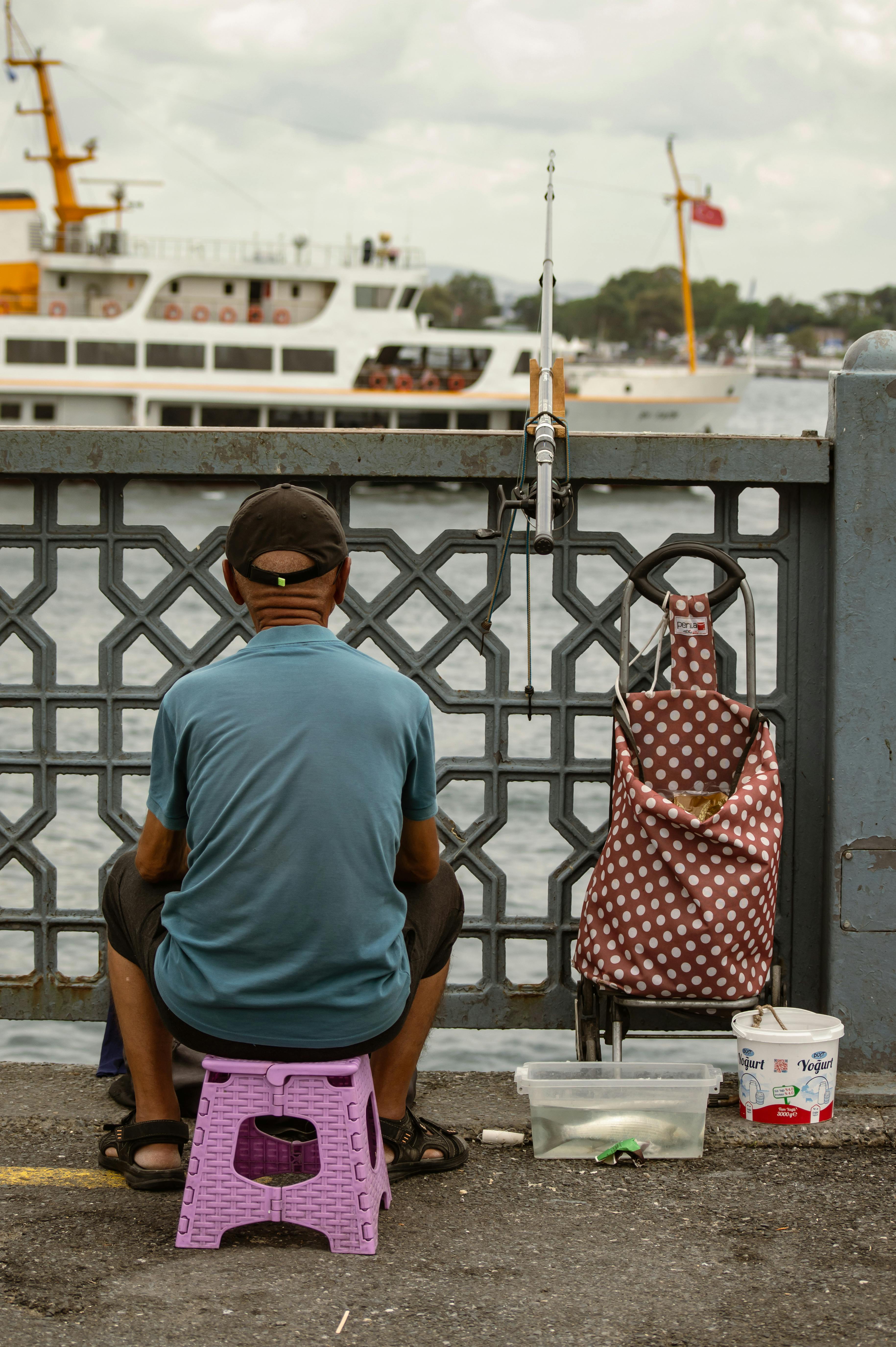 Back View of a Man Fishing from a Pier · Free Stock Photo
