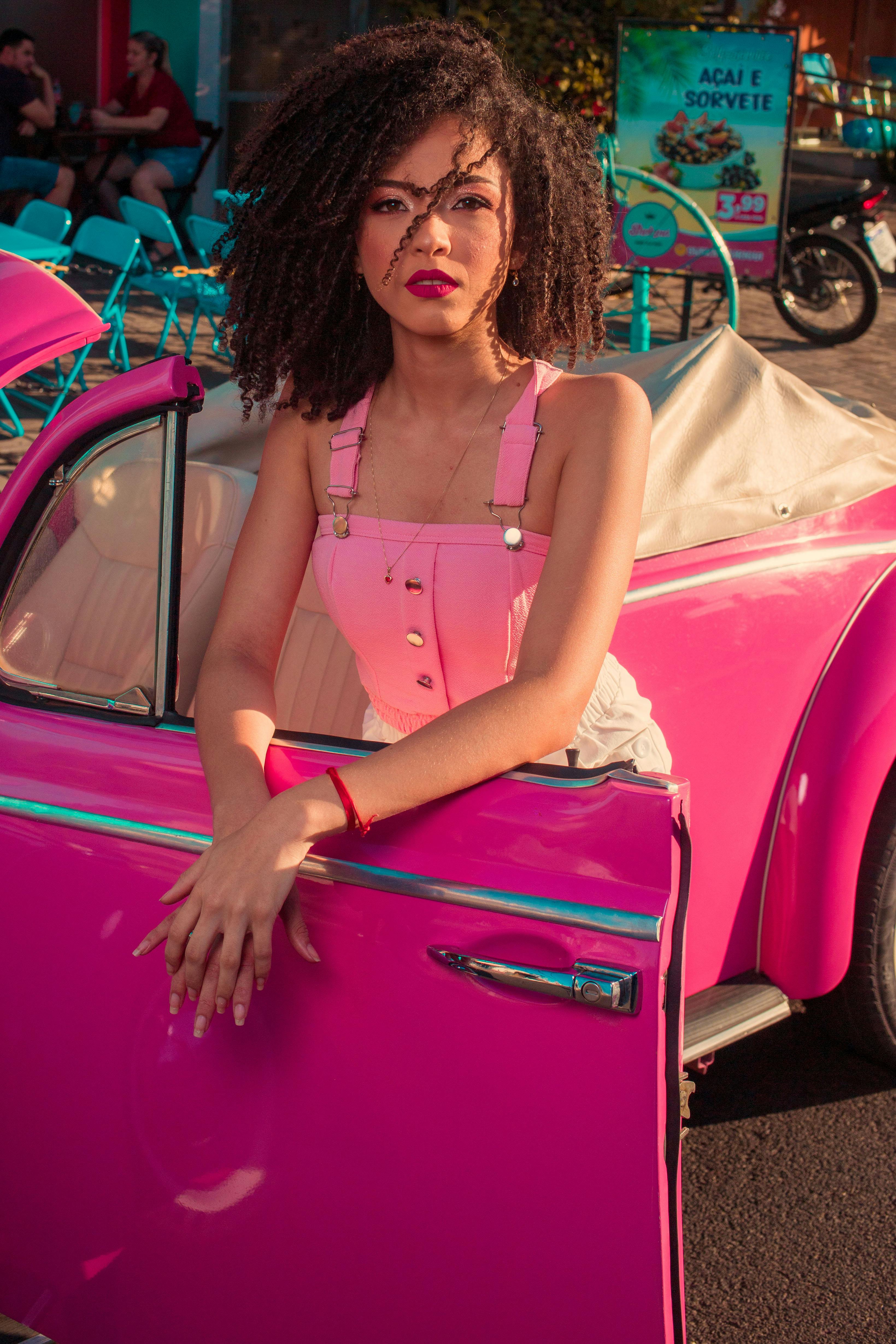 Beautiful Woman Posing on a Pink Car · Free Stock Photo