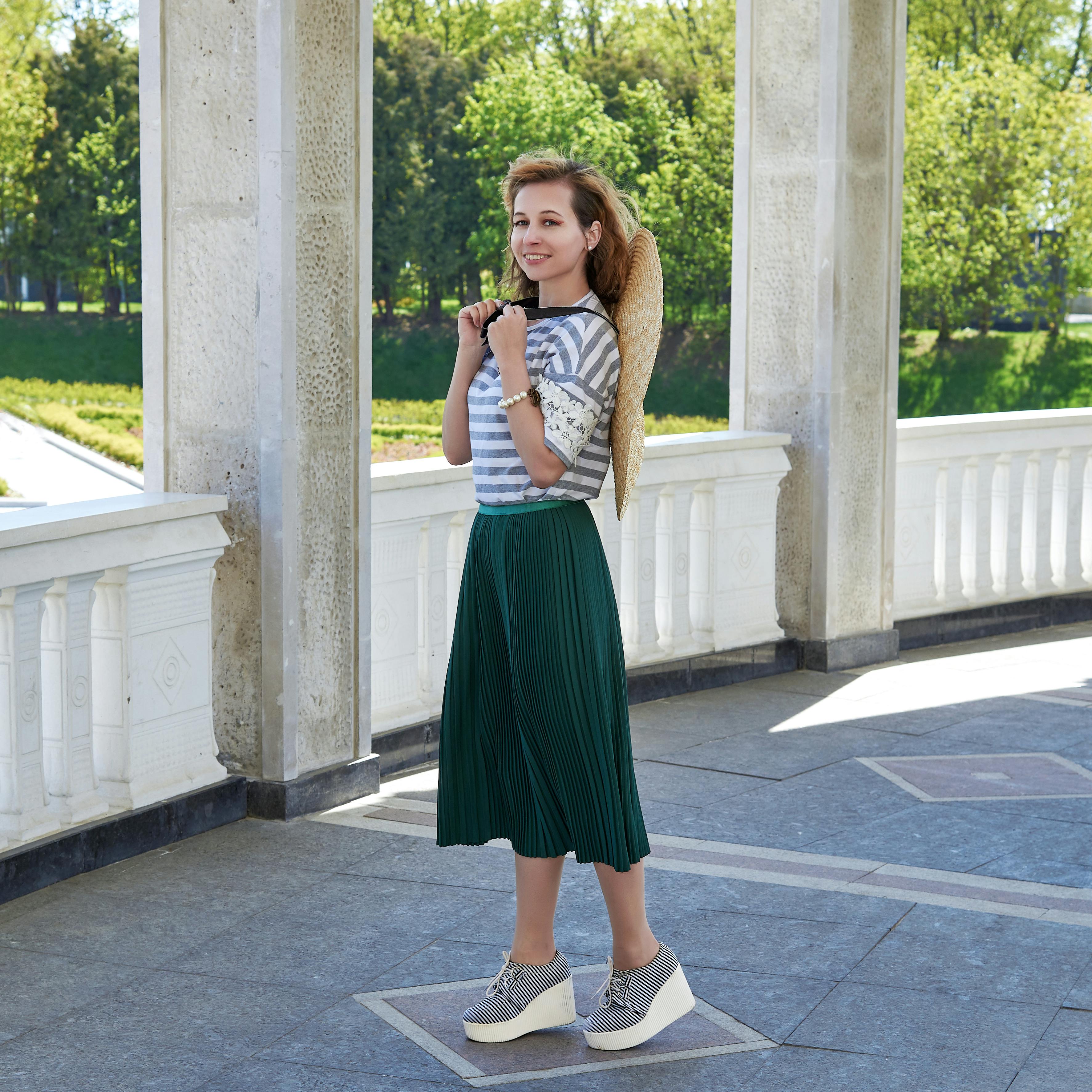 Portrait of a Woman in Traditional Clothing with Striped Skirt and ...