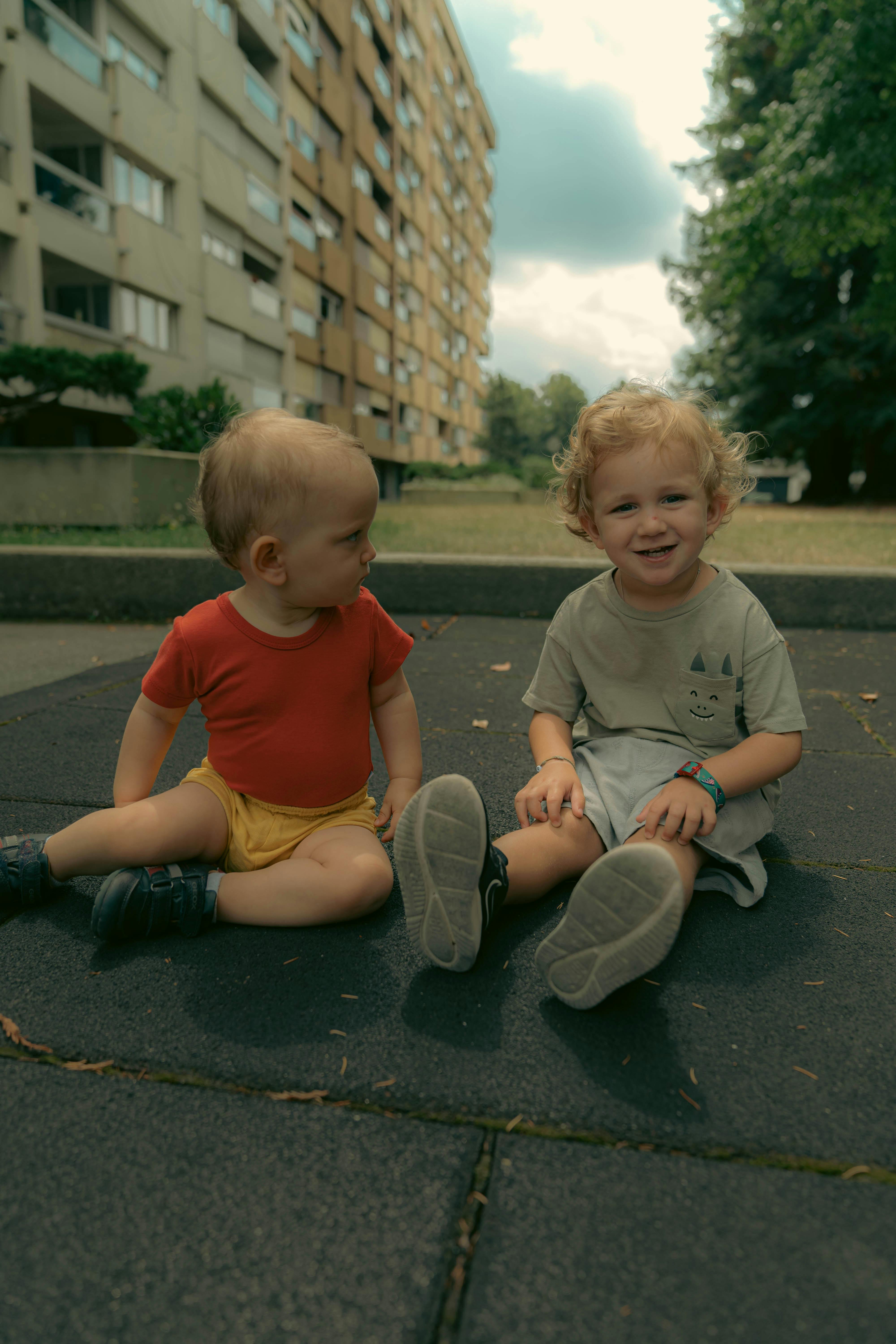 Photo of Kids Sitting on Pavement · Free Stock Photo