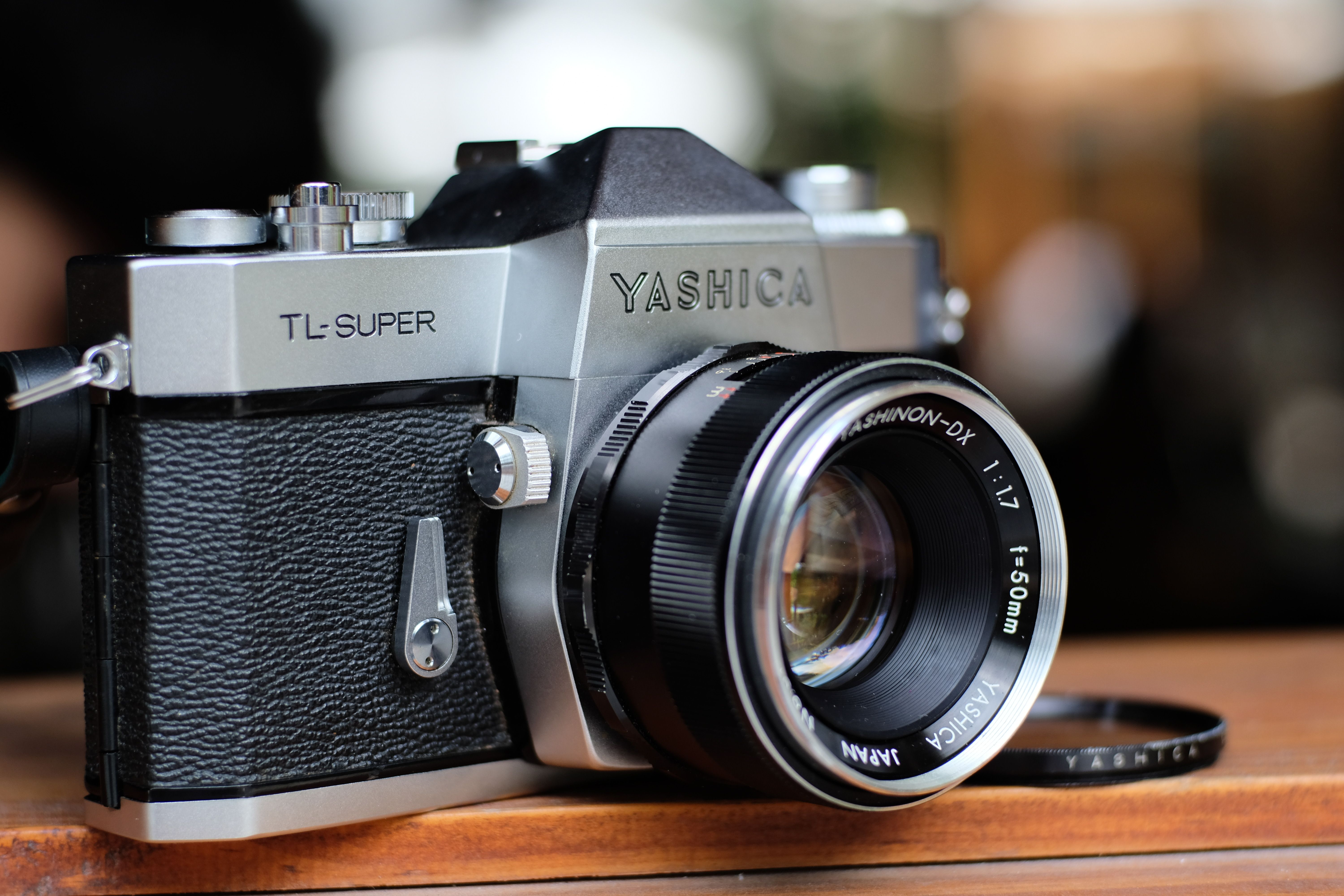 Blakc Camera on White Textile · Free Stock Photo