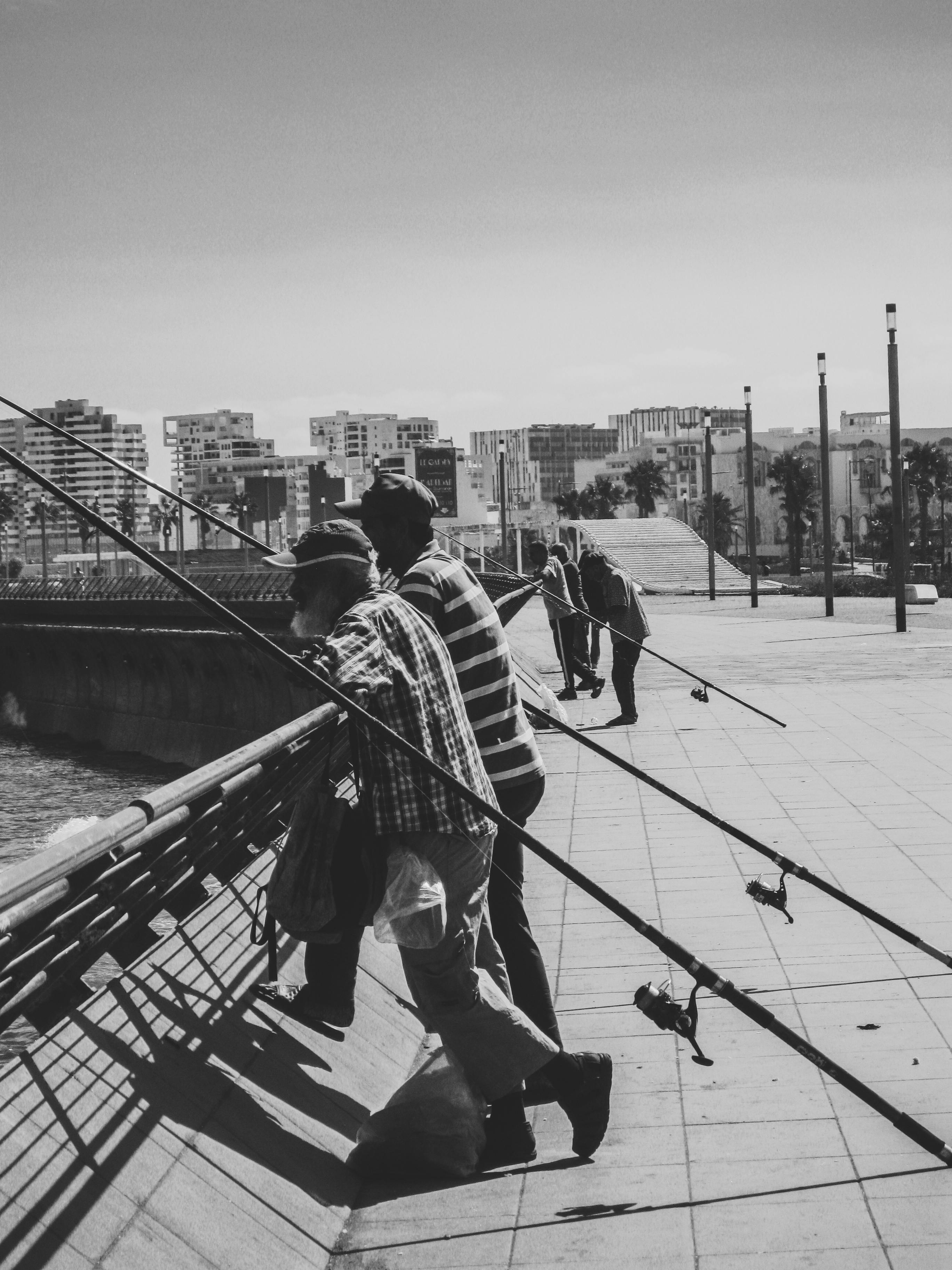 Grayscale Photo of a Person Reading a Book to a Baby with Pacifier ...