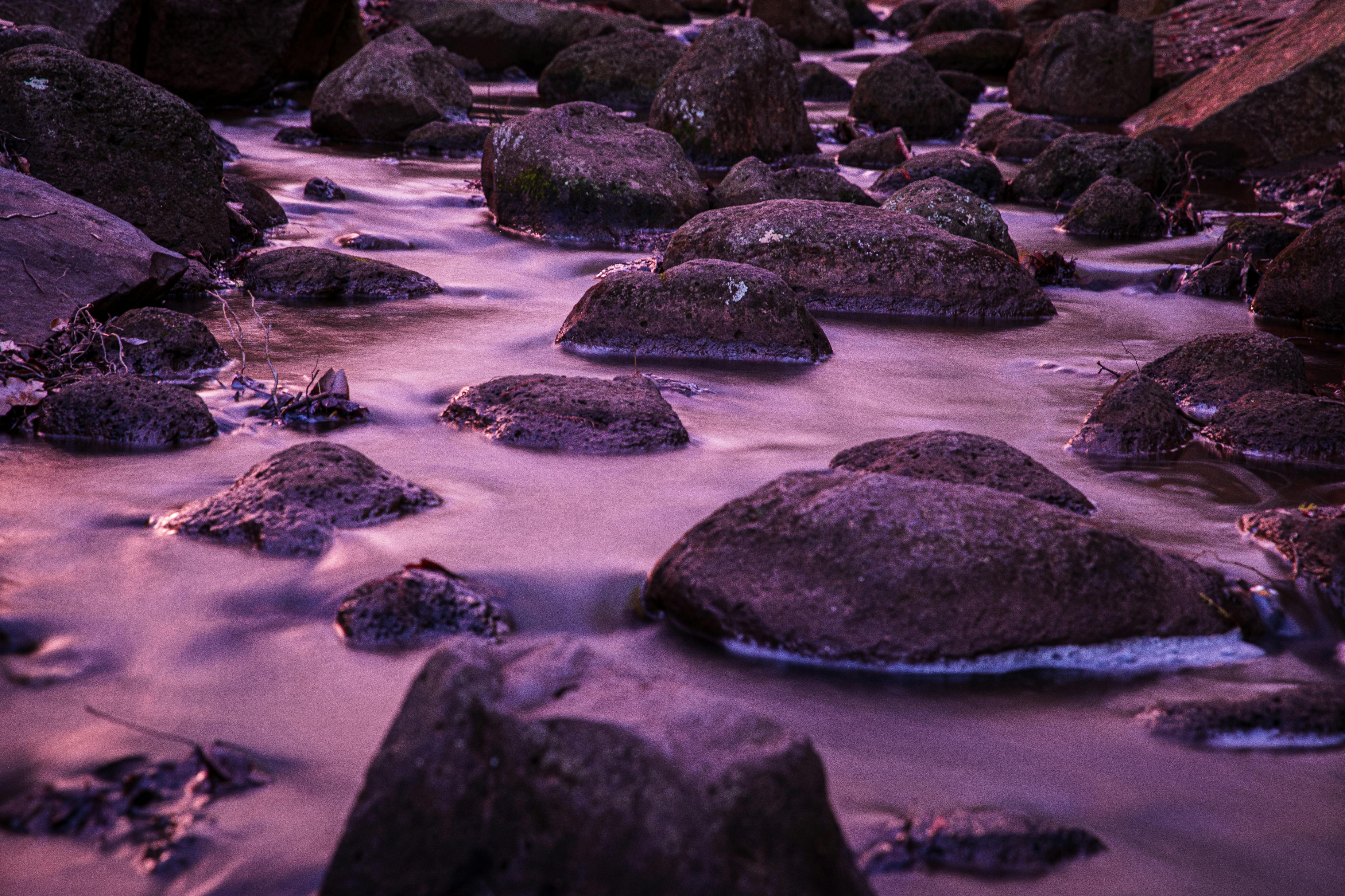 Long Exposure Picture of Water Flowing between Rocks · Free Stock Photo
