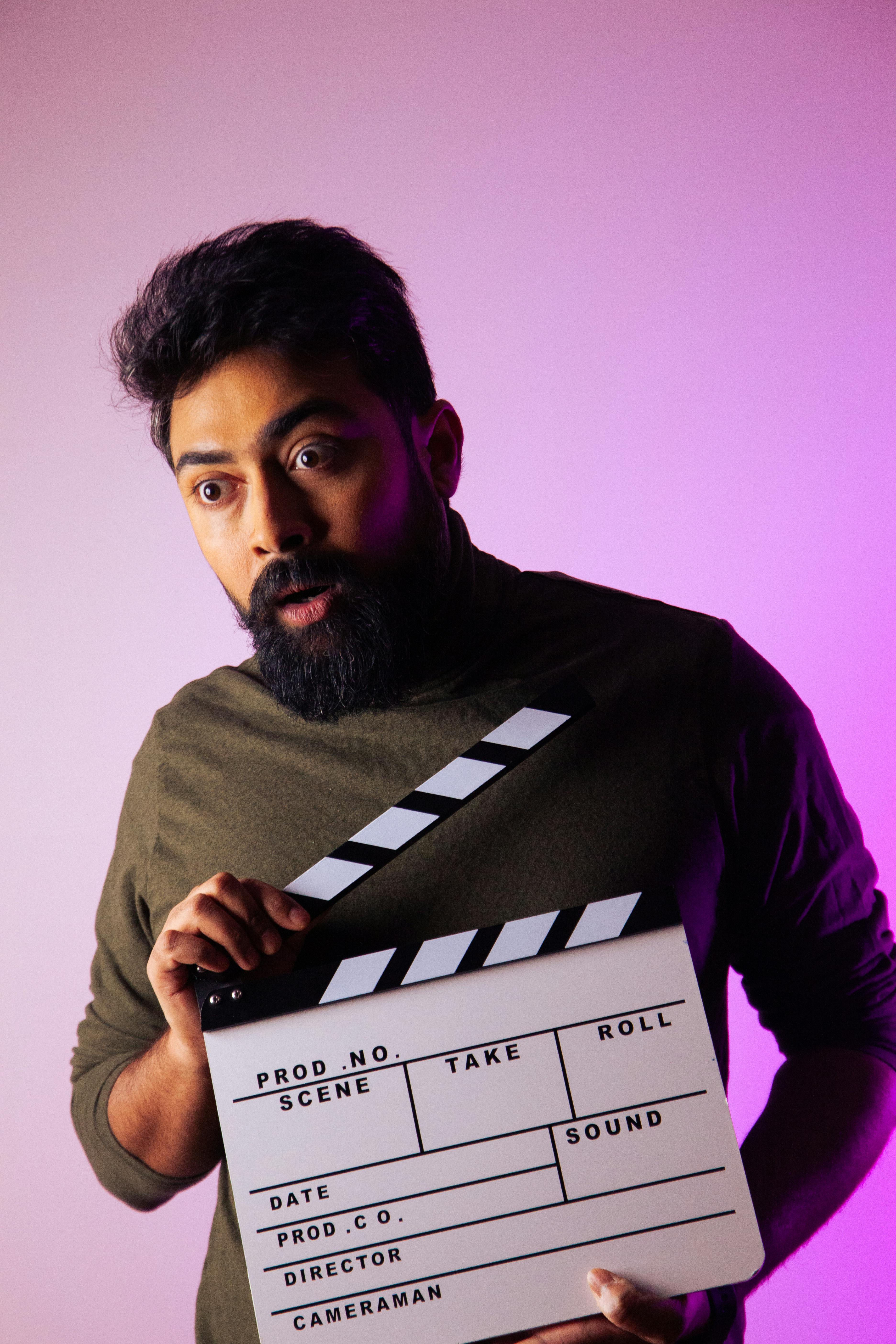 Shocked Actor Holding Clapperboard · Free Stock Photo