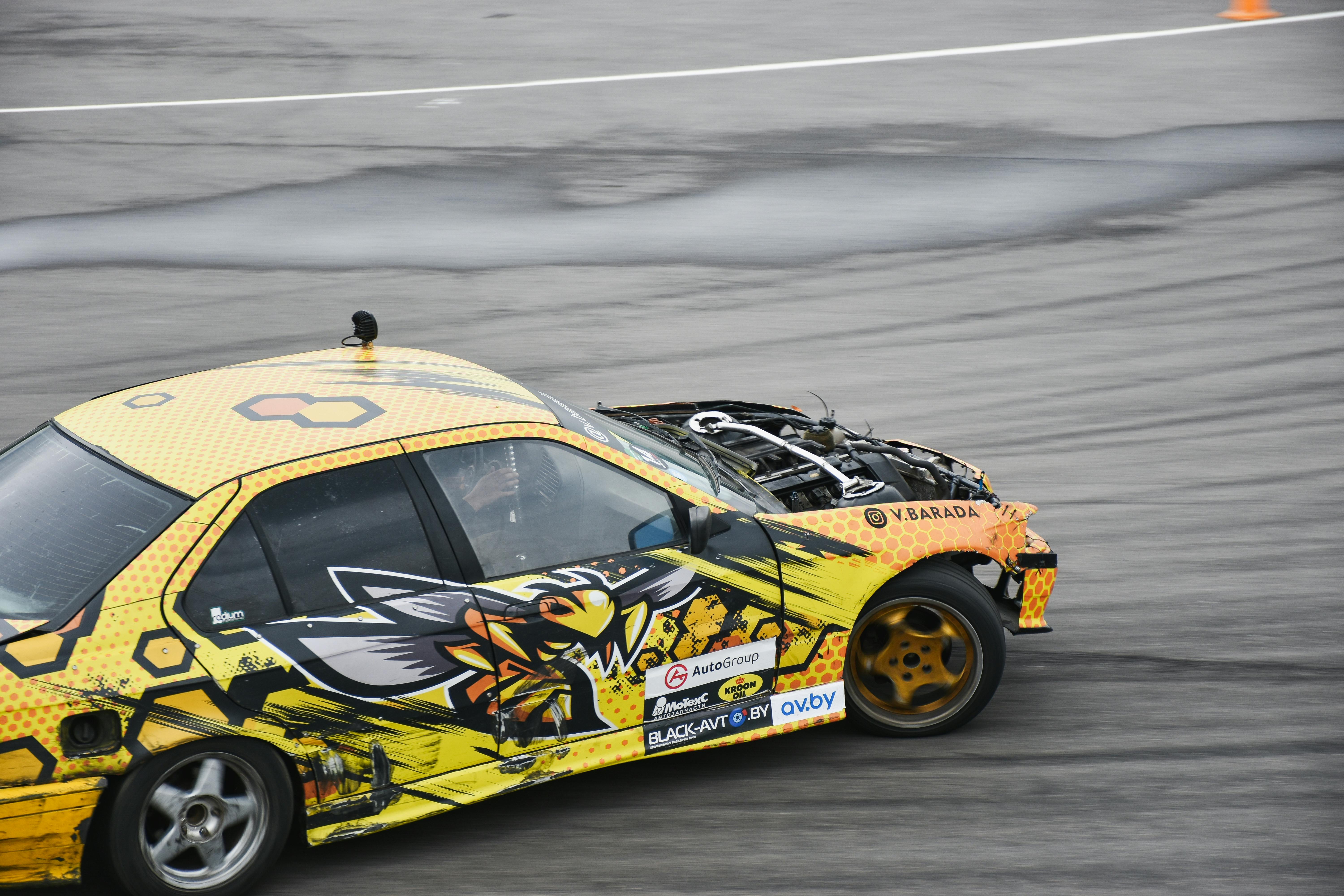 Man in Blue and and White Racer Suit Wearing His Blue and Yellow Star ...