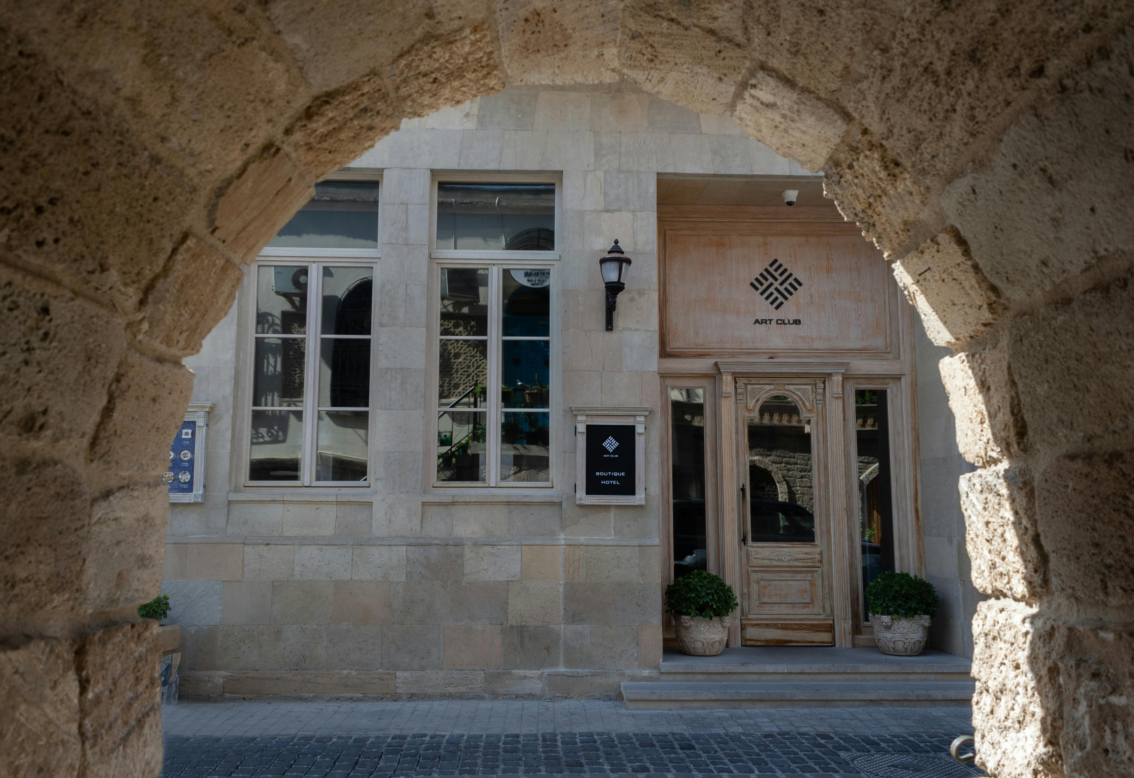 A Crown Concrete Building Near Arched Passage · Free Stock Photo