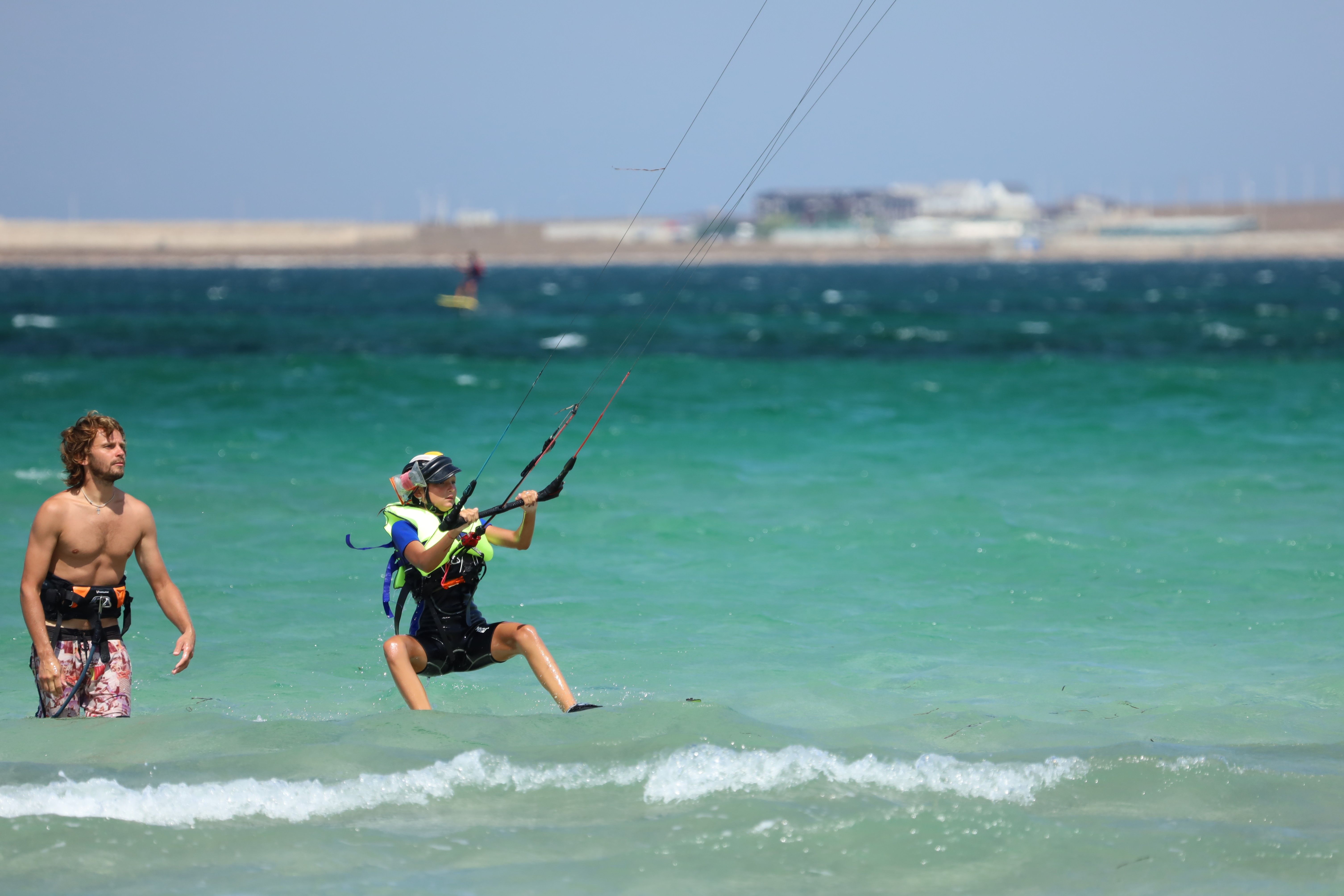 Low-Angle Shot of a Man Kiteboarding in the Sea · Free Stock Photo