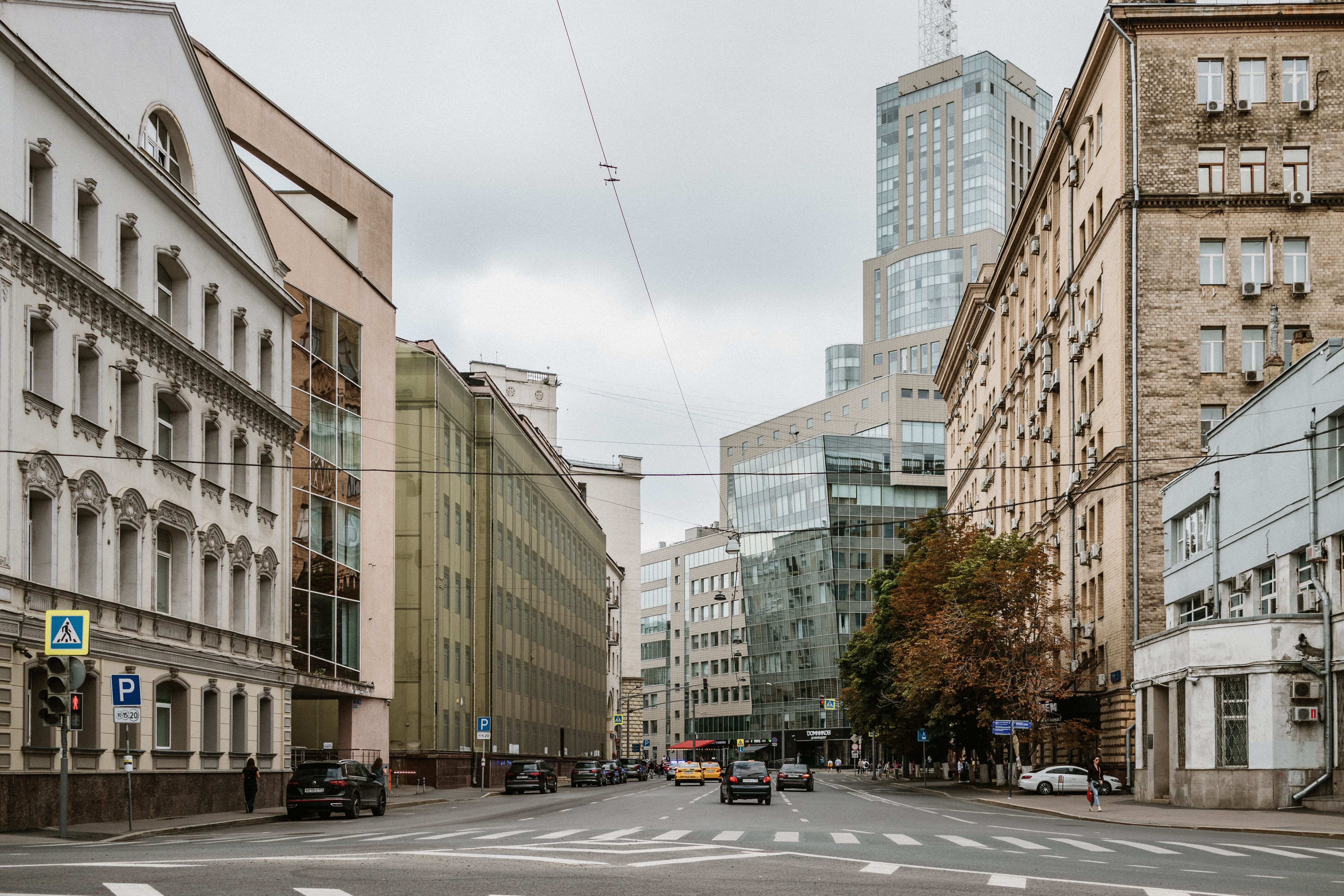 Parked Cars on the Street between Concrete Buildings · Free Stock Photo