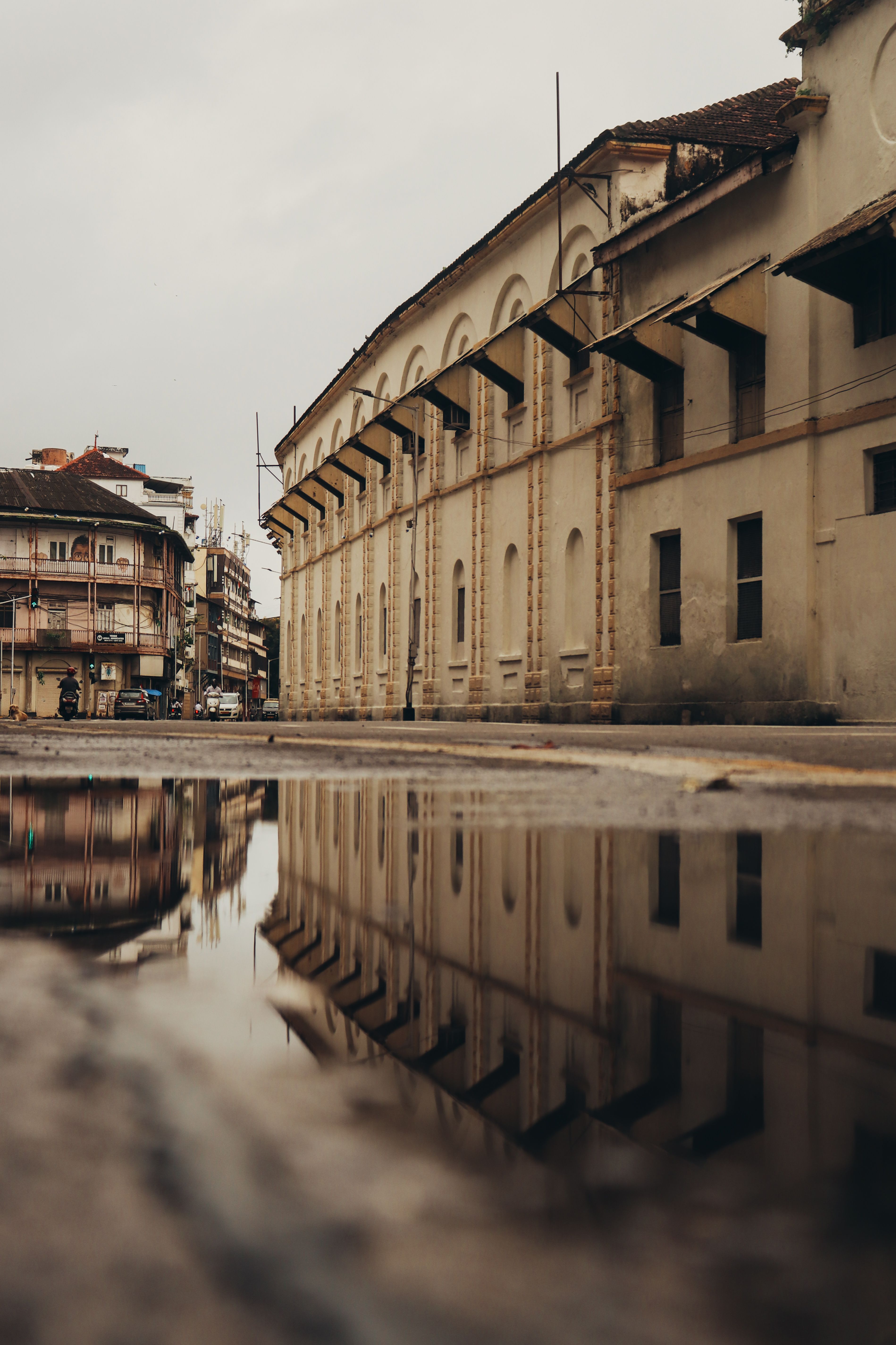 Building Reflecting in a Puddle on a Street · Free Stock Photo