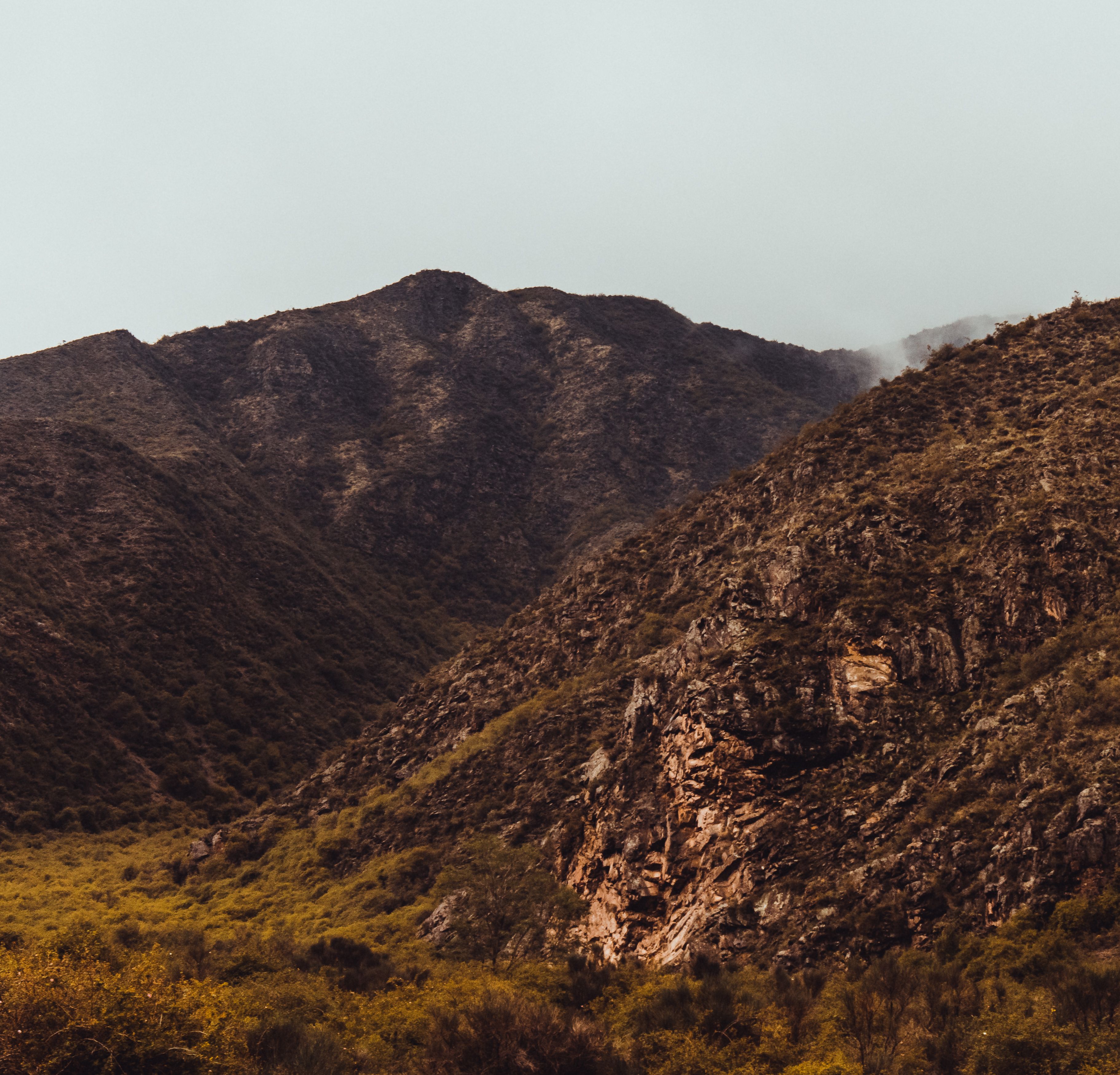 Brown Mountains Under Gray Sky · Free Stock Photo