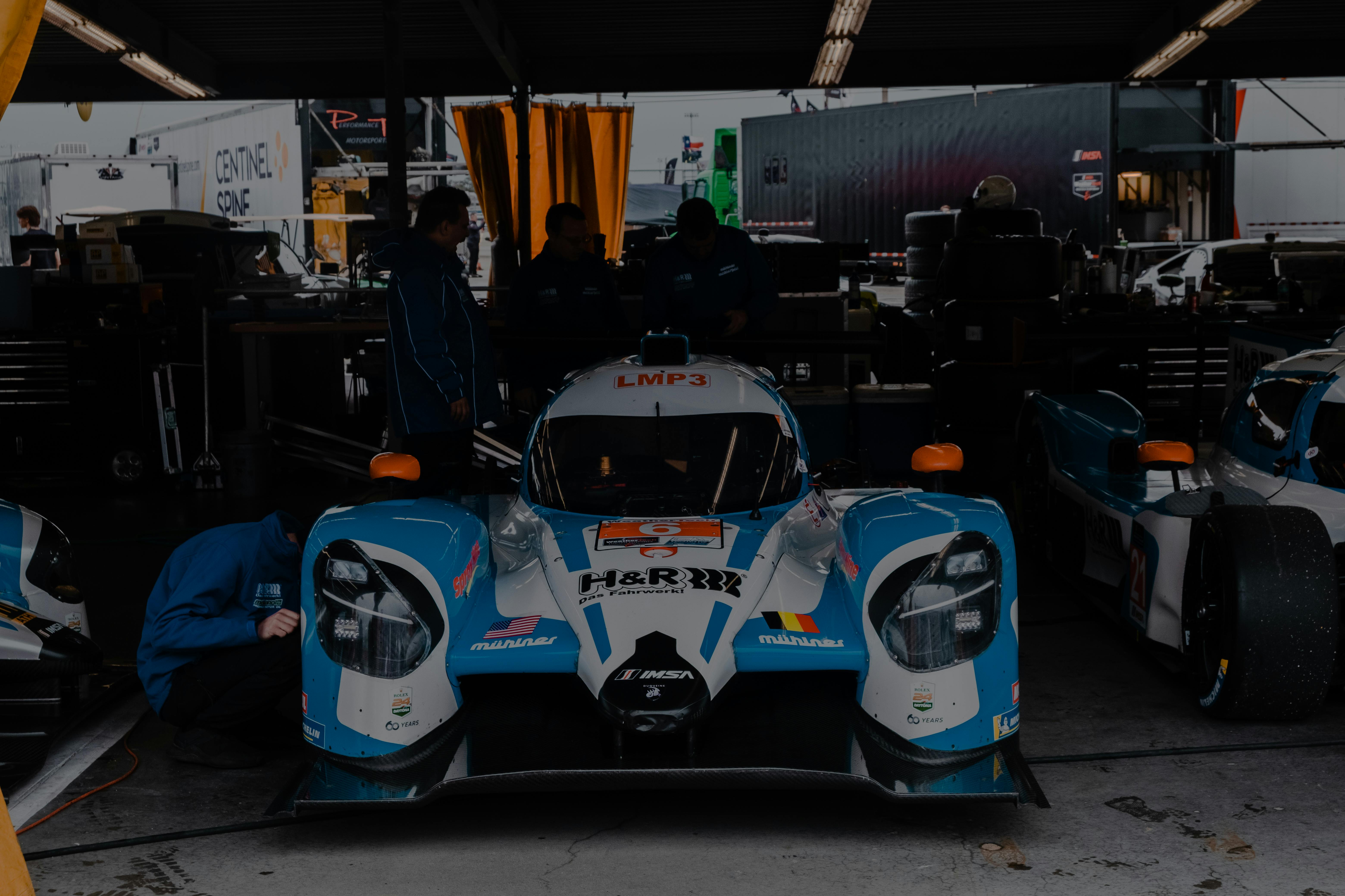 Blue Racing Car in a Garage · Free Stock Photo