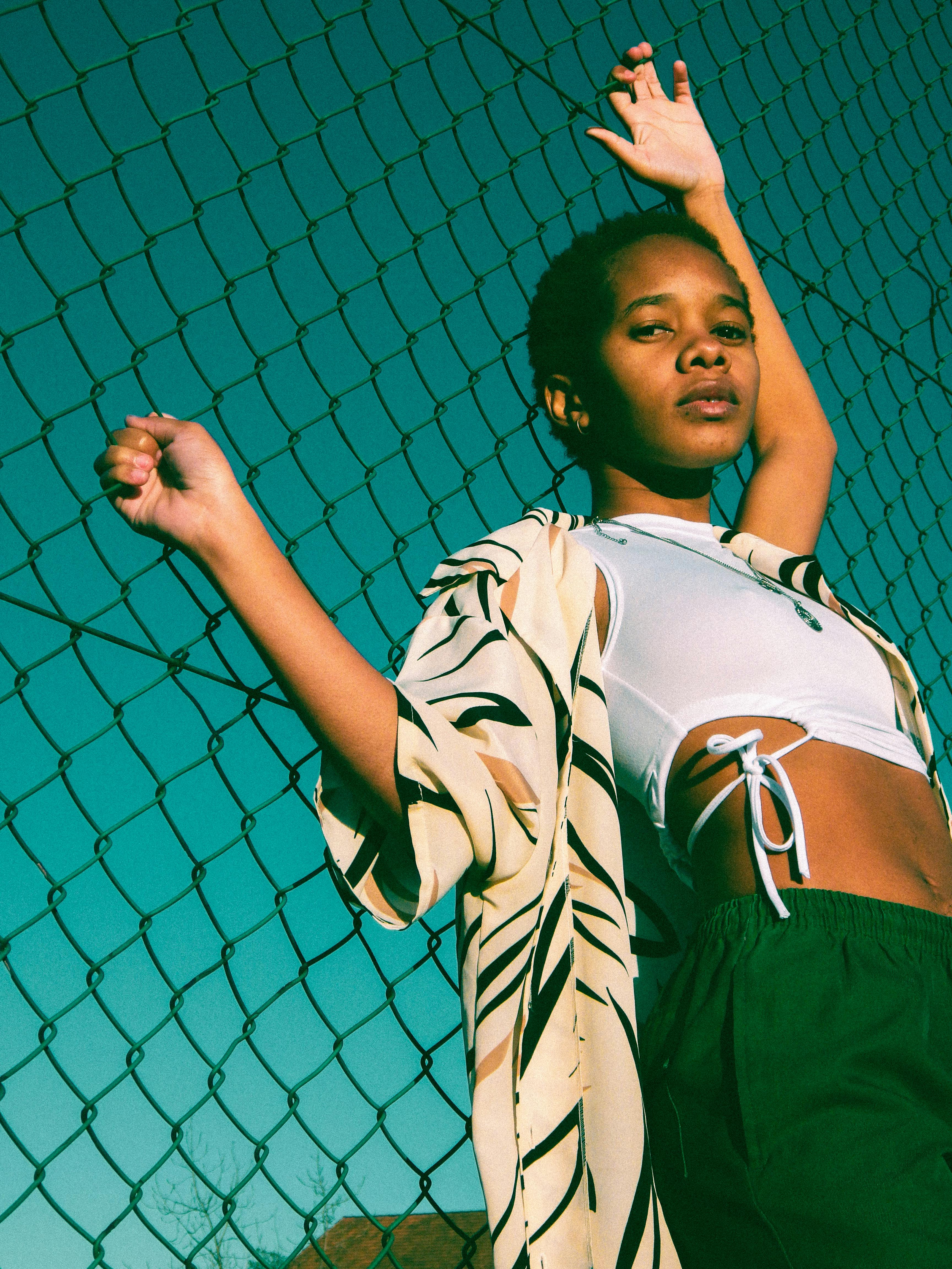 Woman Leaning on a Fence · Free Stock Photo