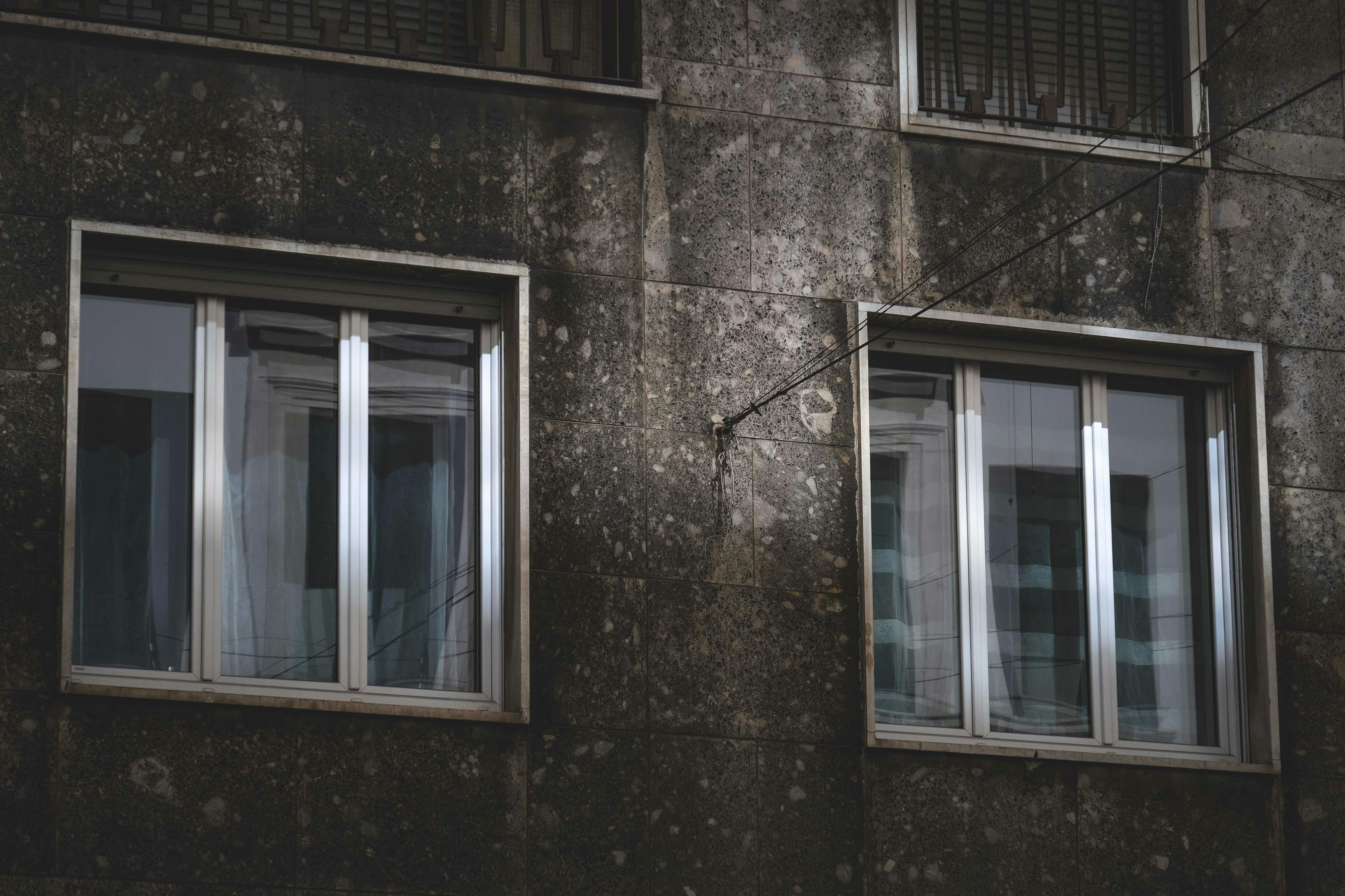 Glass Windows on a Concrete Building · Free Stock Photo