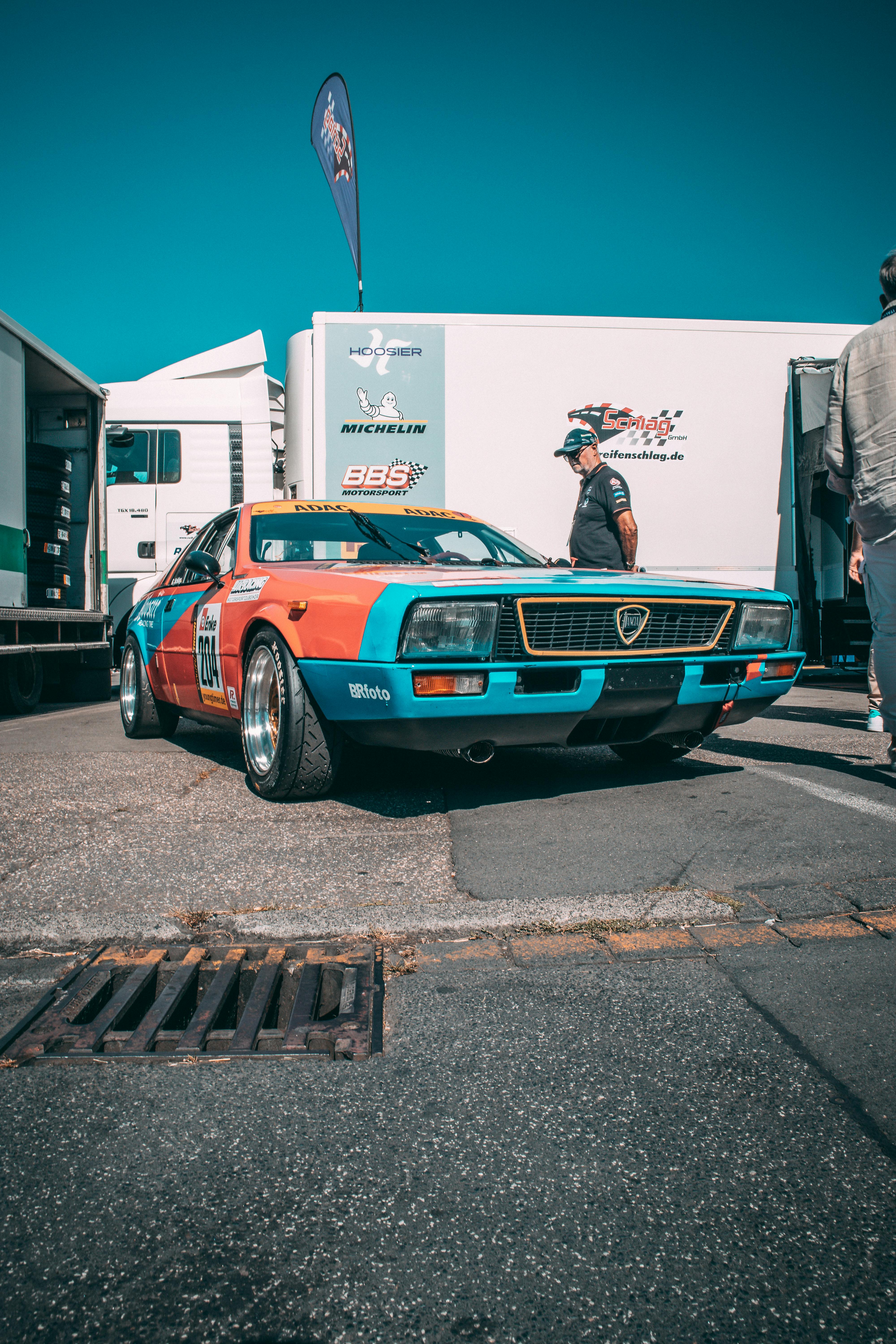 A Sports Car on the Asphalt Parking Lot · Free Stock Photo