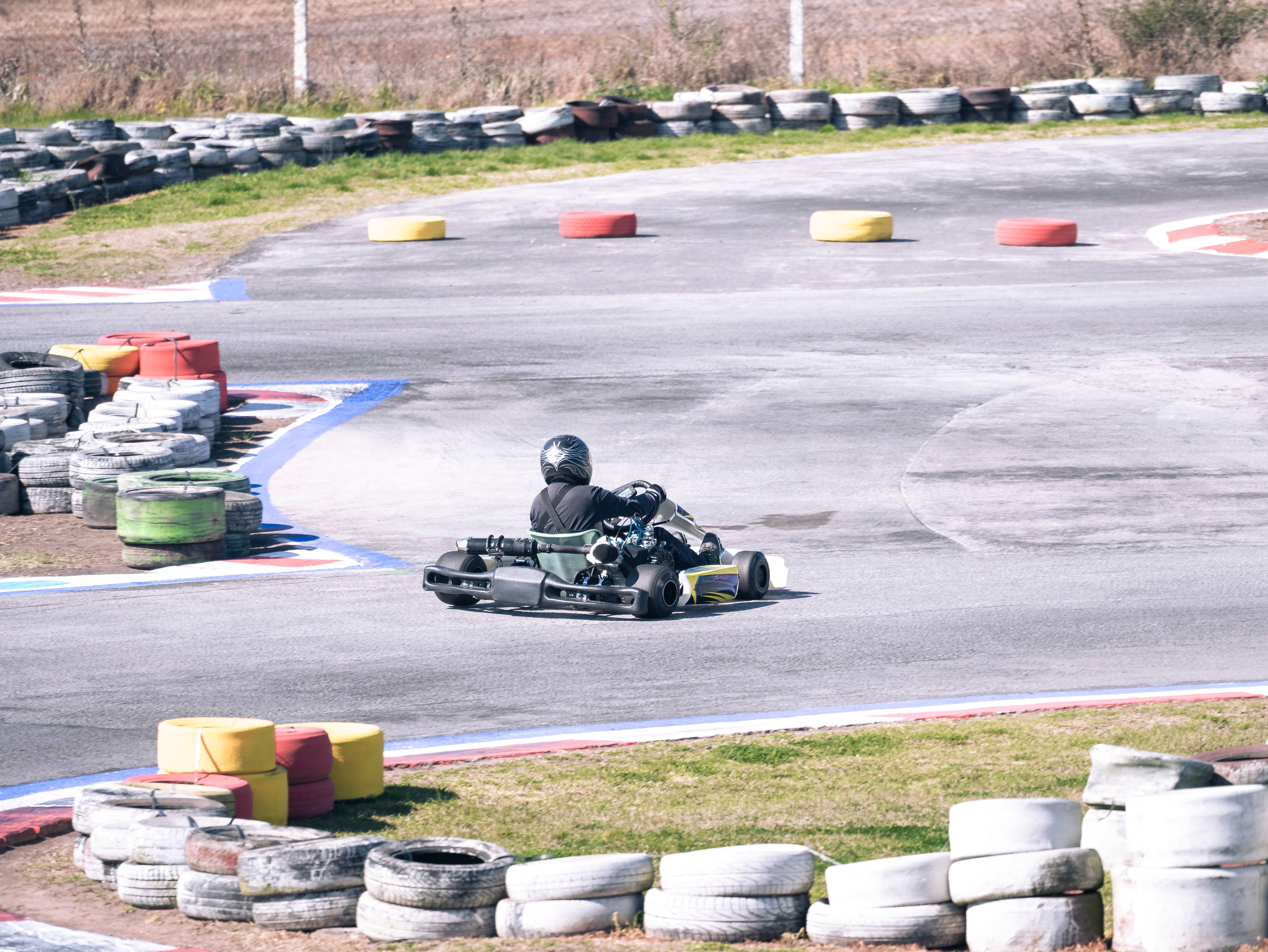 Man Wearing Green Helmet Riding Go Kart · Free Stock Photo