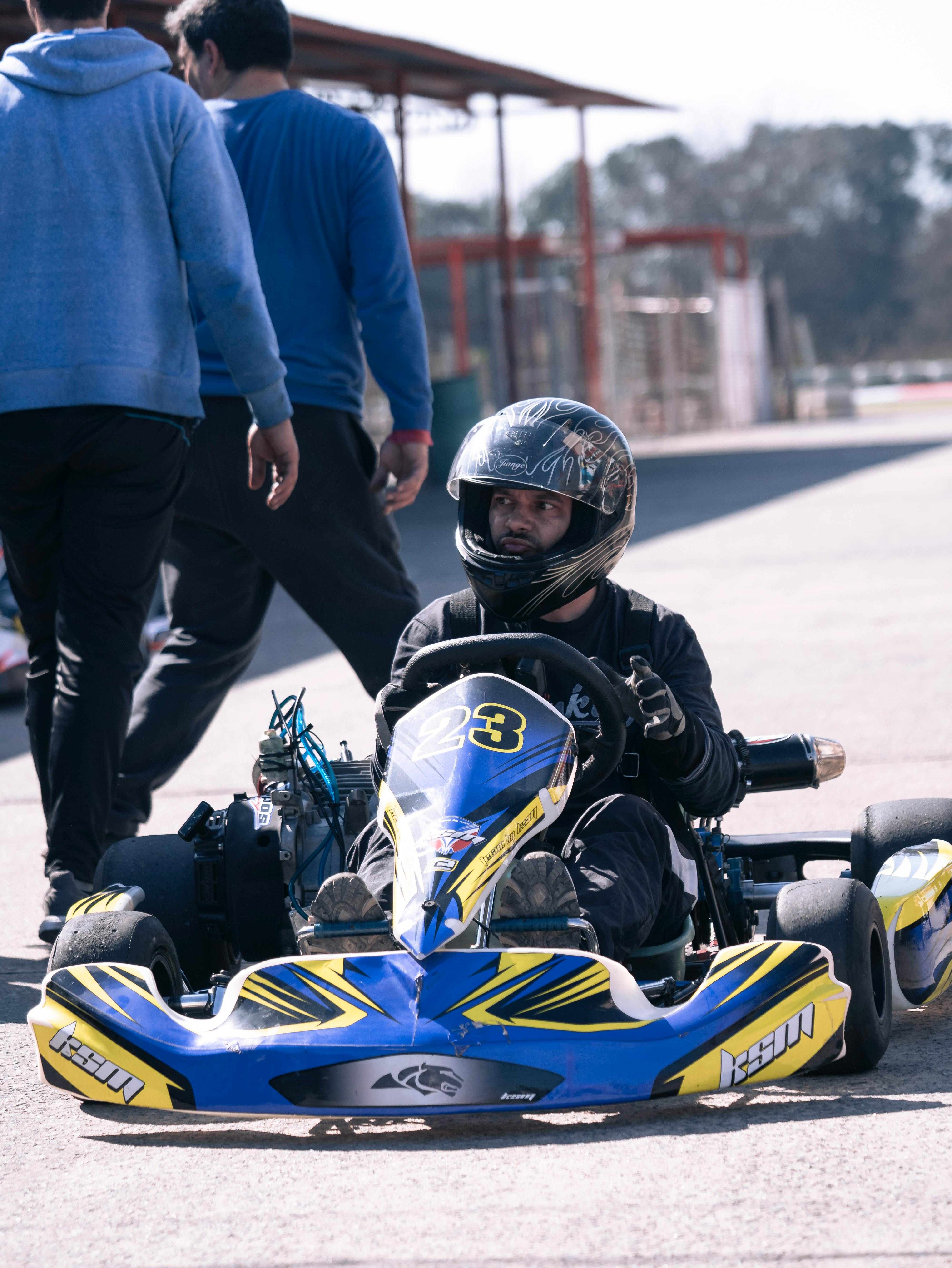 Man Wearing a Helmet Driving a Go Kart · Free Stock Photo