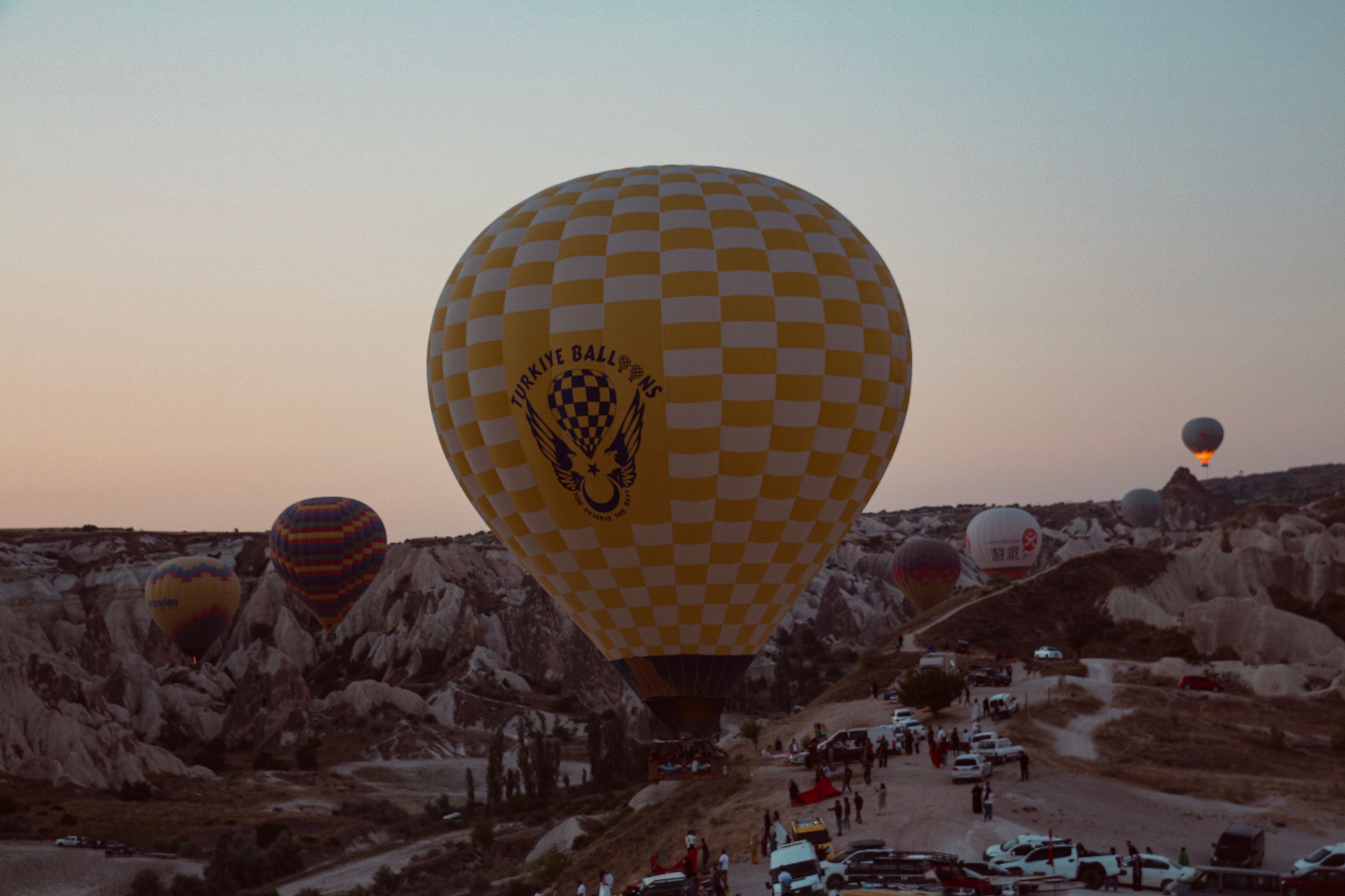 Hot Air Balloon Flying in Rocky Landscape · Free Stock Photo