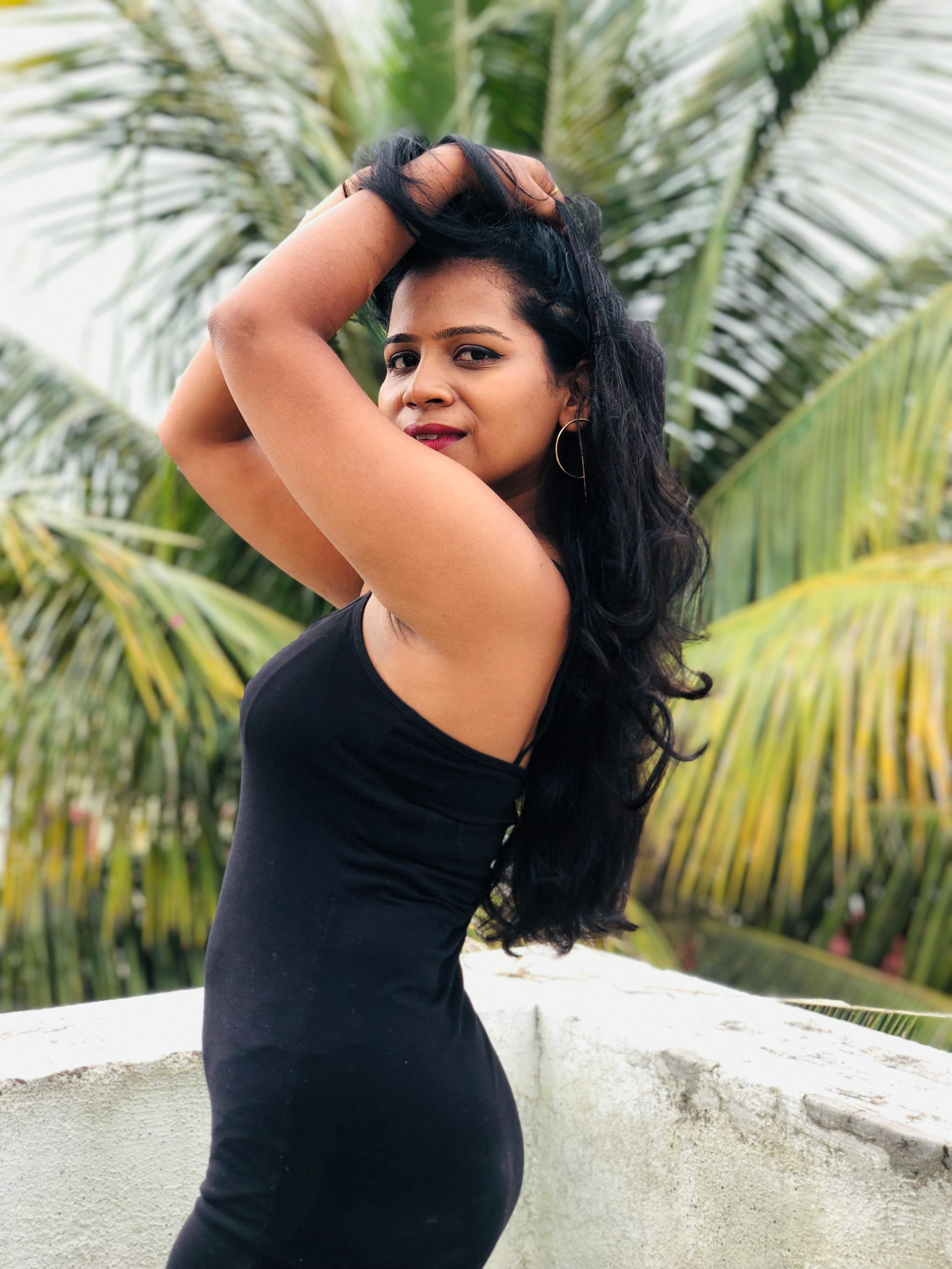 Woman in a Red Dress Posing on a Poolside · Free Stock Photo