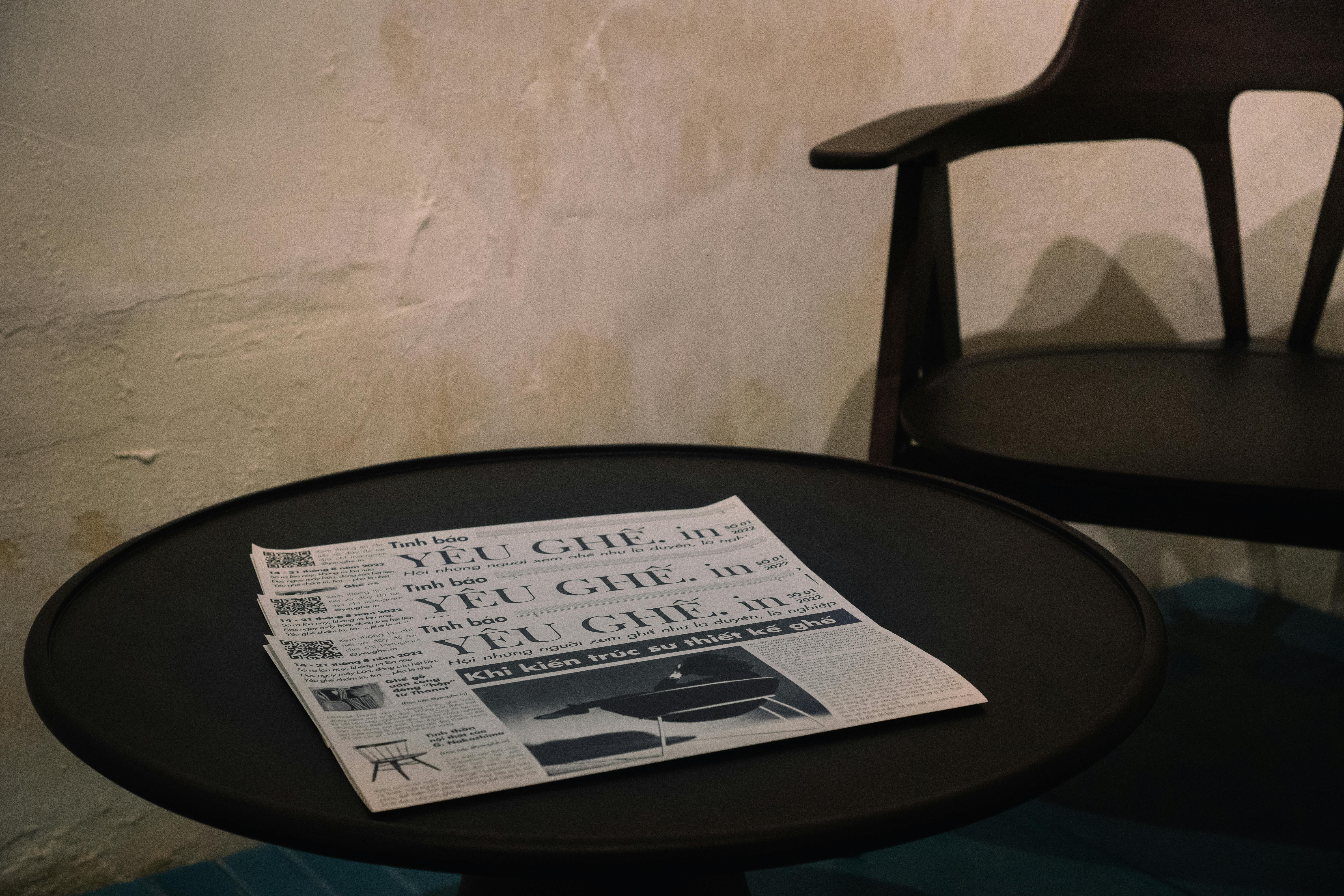 Newspapers on Black Round Table · Free Stock Photo