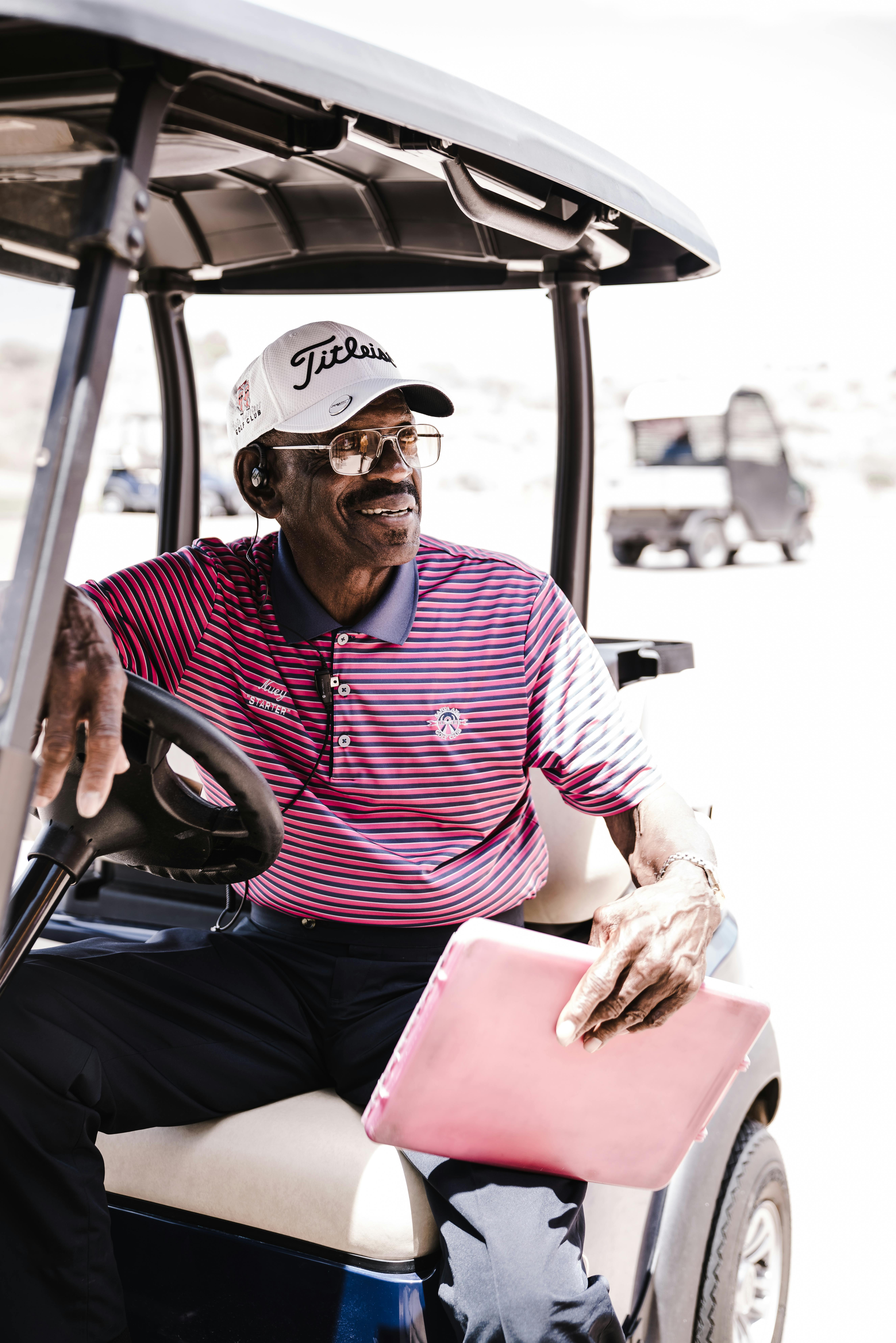 Photo of Man Sitting on Golf Cart · Free Stock Photo