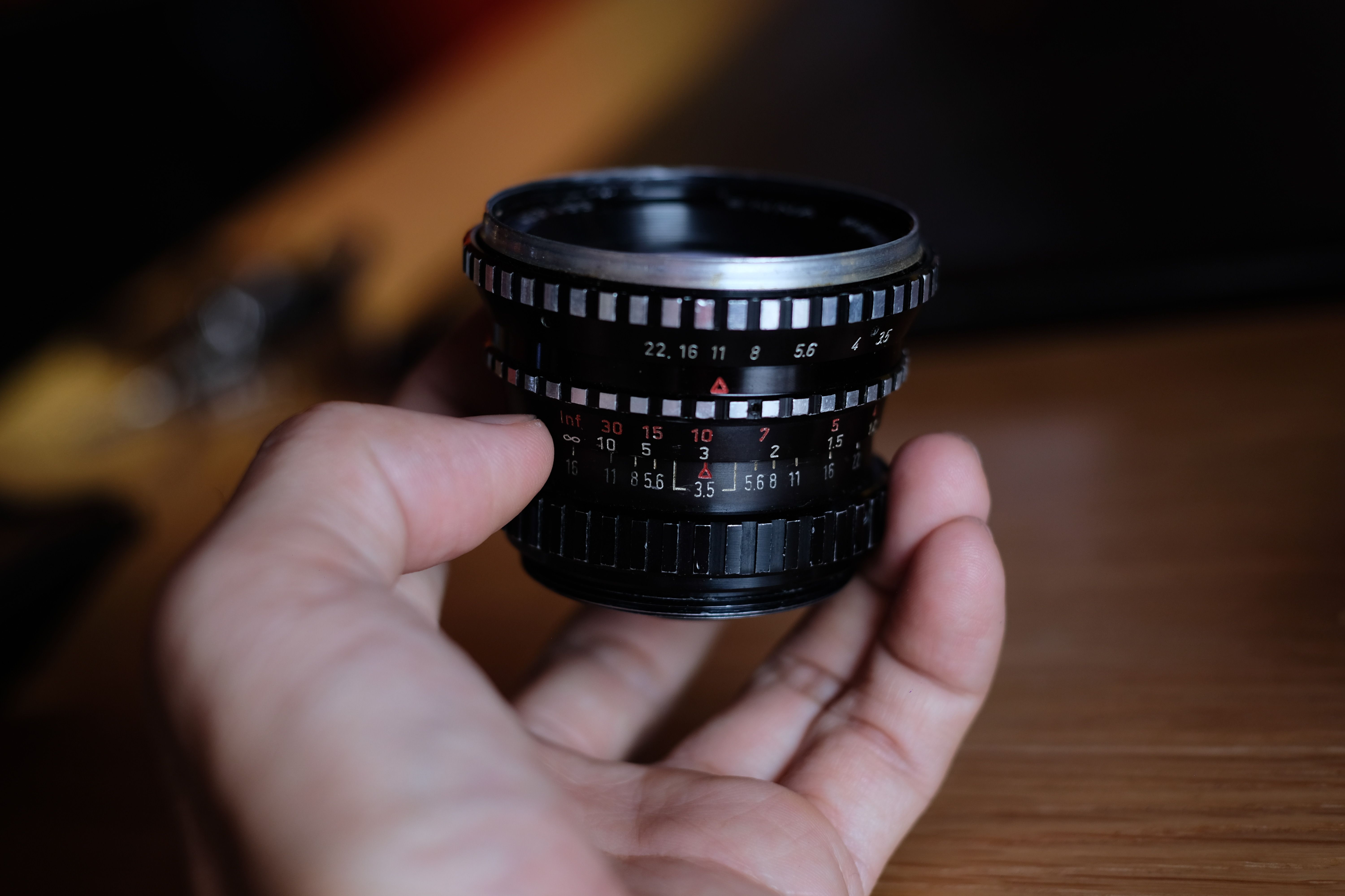 A Hand Holding a Camera Lens · Free Stock Photo