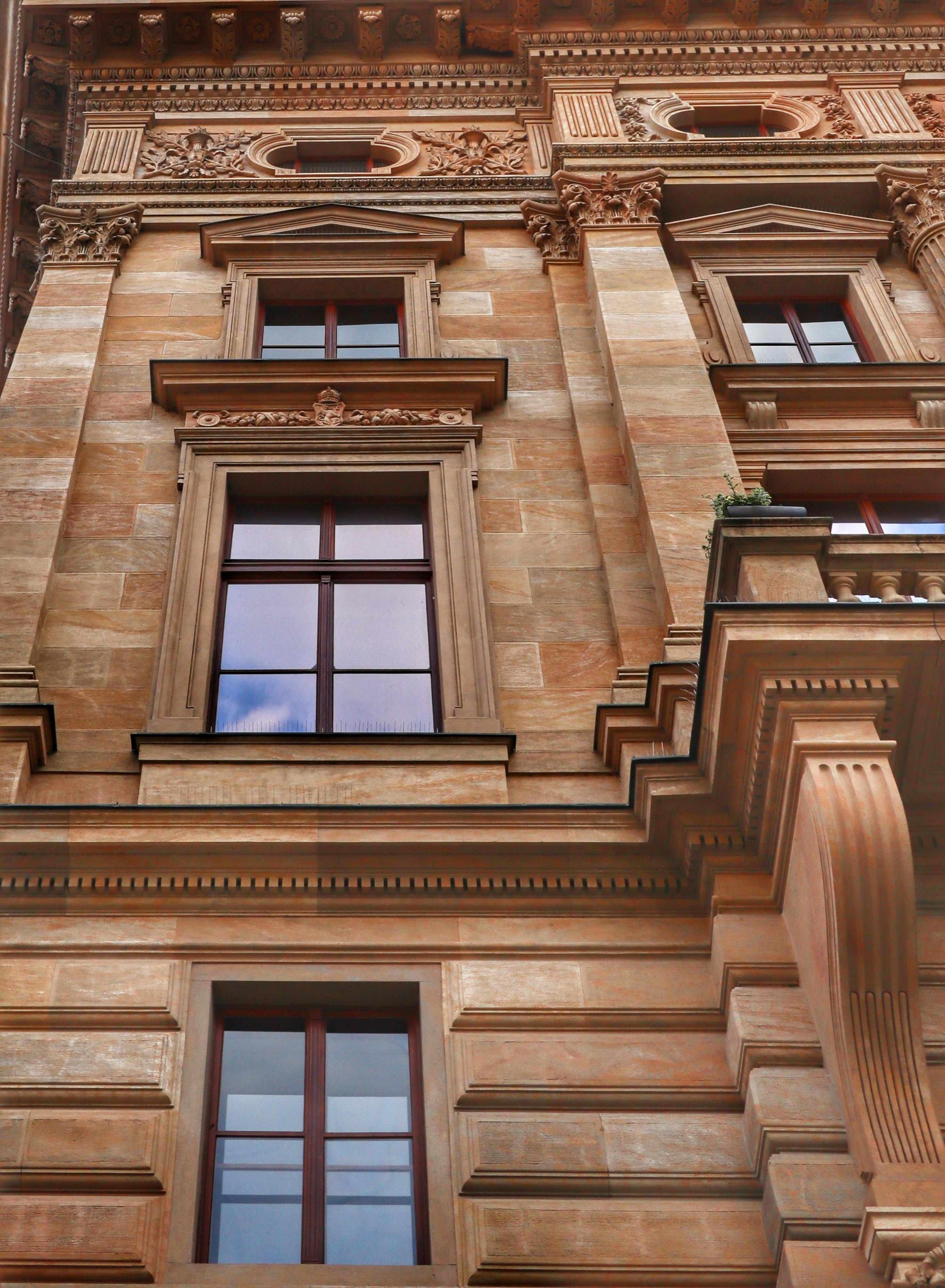 Old stone building exterior with decor in town · Free Stock Photo
